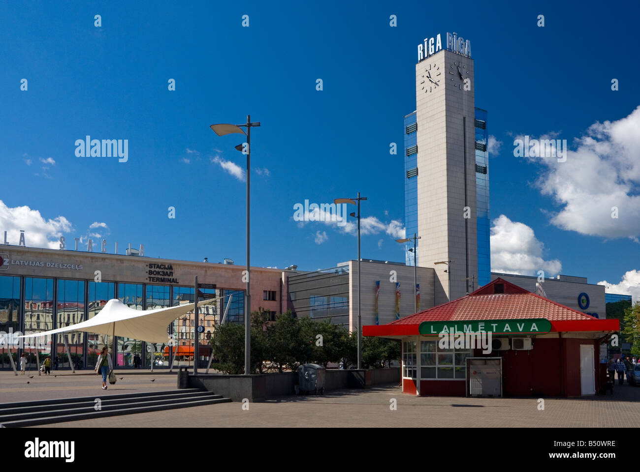 The Riga central train station with clock tower and stalls around it ...