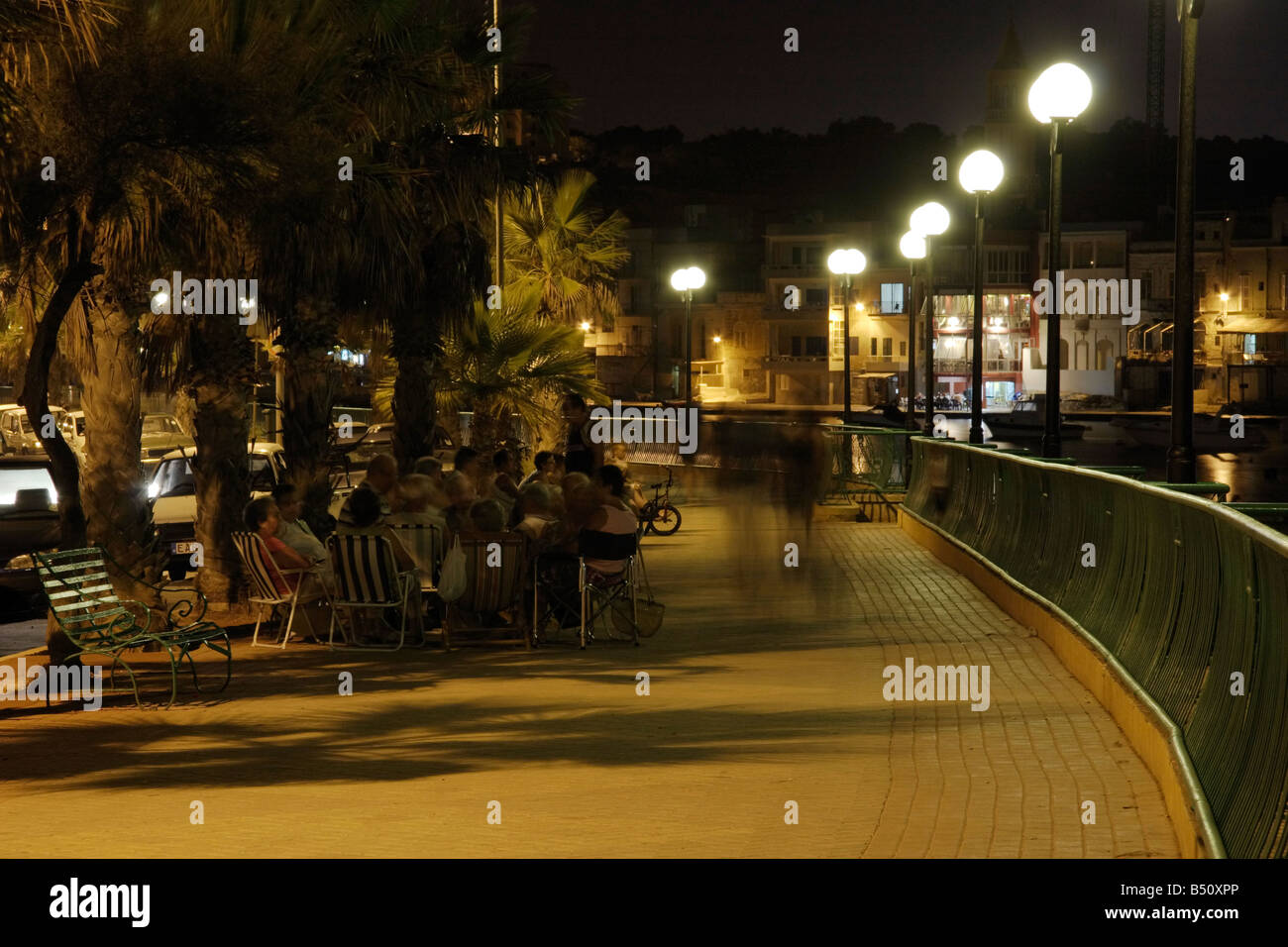 Maltese families sitting out on the Promenade in Marsaskala in the ...