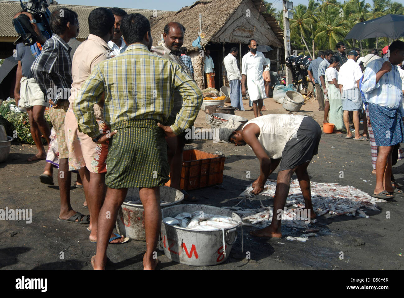 Fishermen selling fish in the coastal village of Kerala, India Stock ...