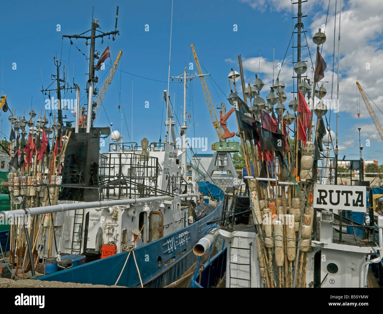 fishingboats with flags for fishing at wharf and trading port at Baltic ...