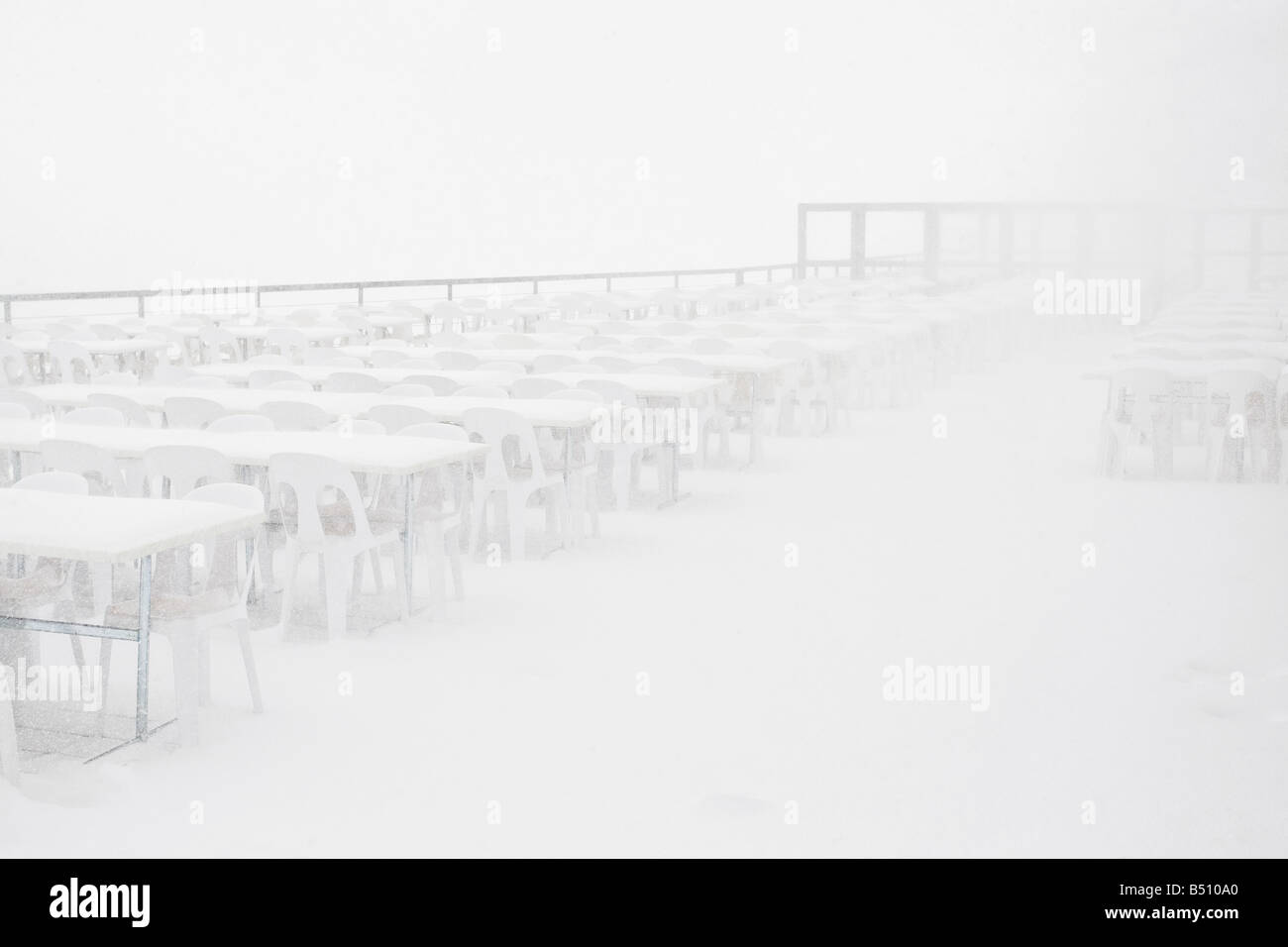 Snow covered tables and chairs in a restaurant Switzerland Stock Photo ...