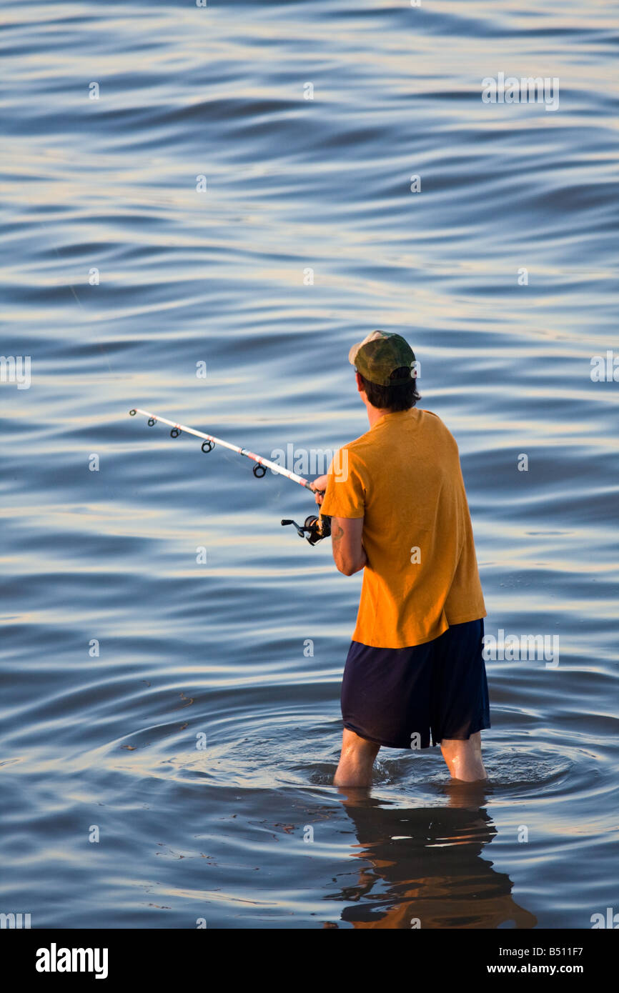 Young male fisherman casting the line at a river Stock Photo - Alamy