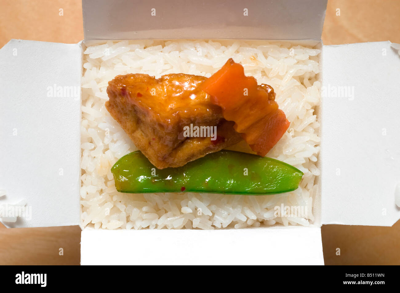 Tofu and Chinese vegetables on a white rice takeout container Stock ...