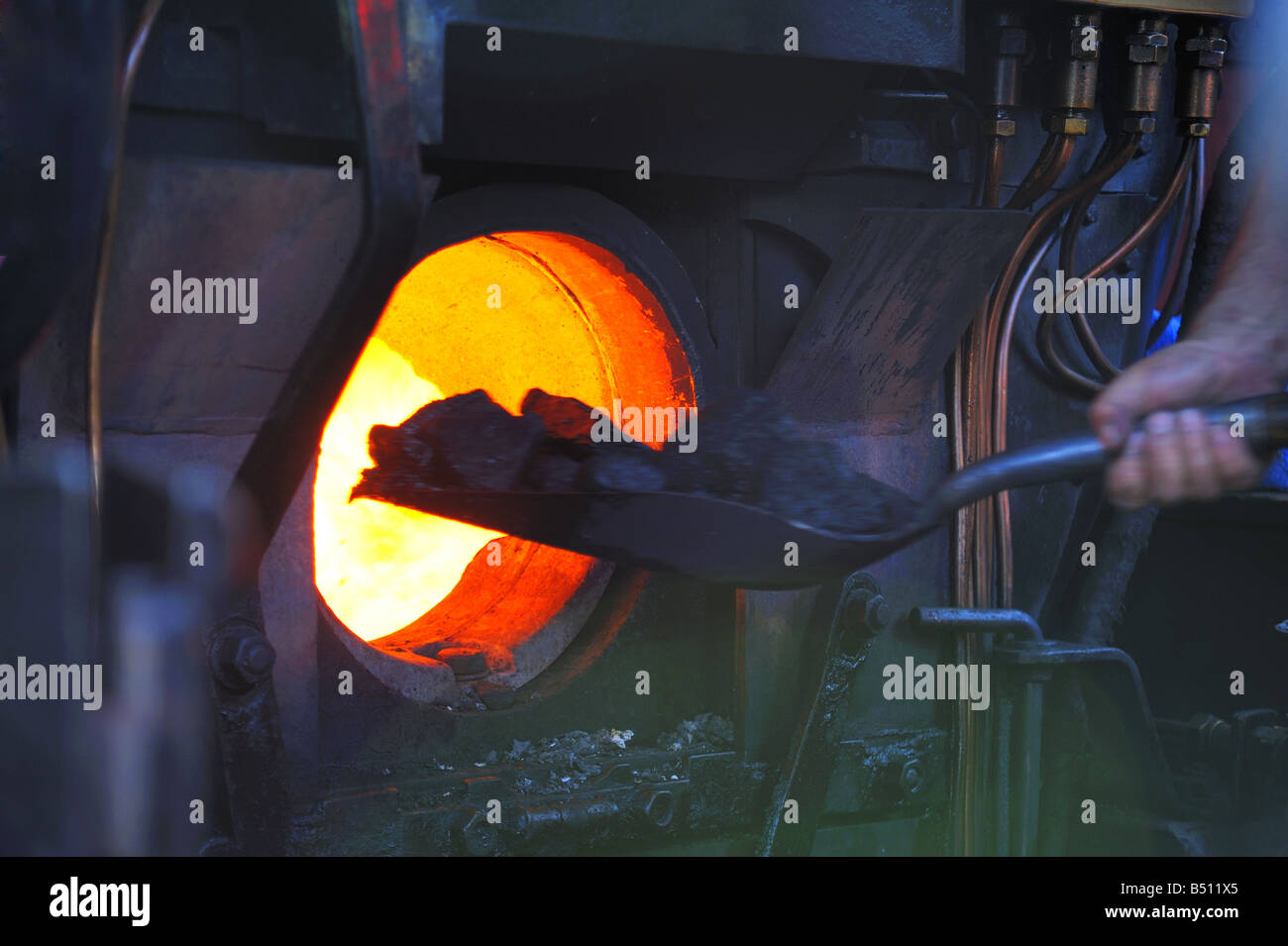 Stoking a fire of a steam locomotive Stock Photo - Alamy