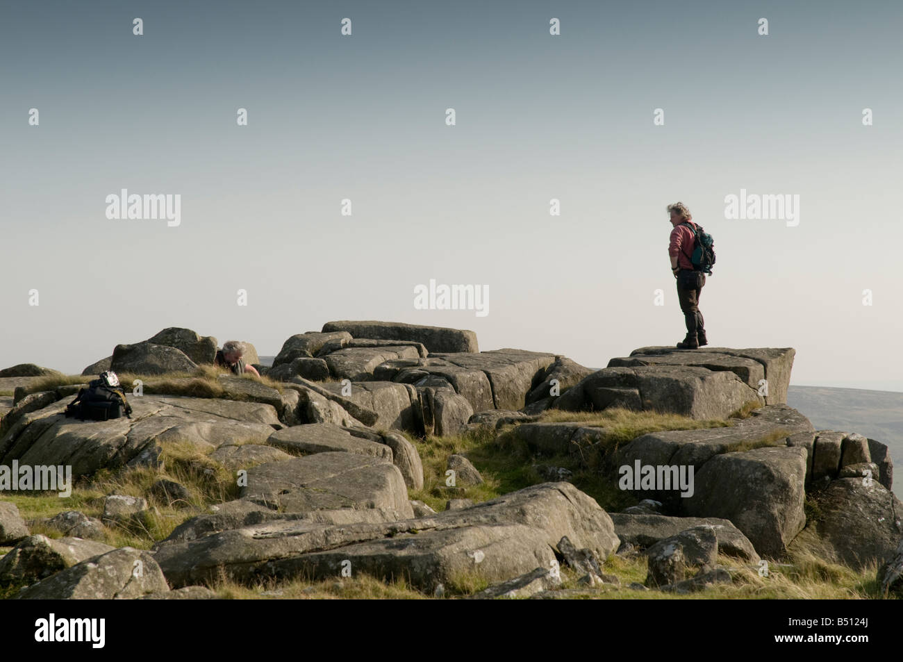 Man, walker hiker, standing on Carn Menyn Carn Meini rocky dolerite ...