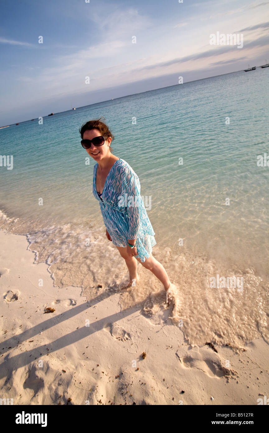 Female on beach holiday at sunset Stock Photo - Alamy