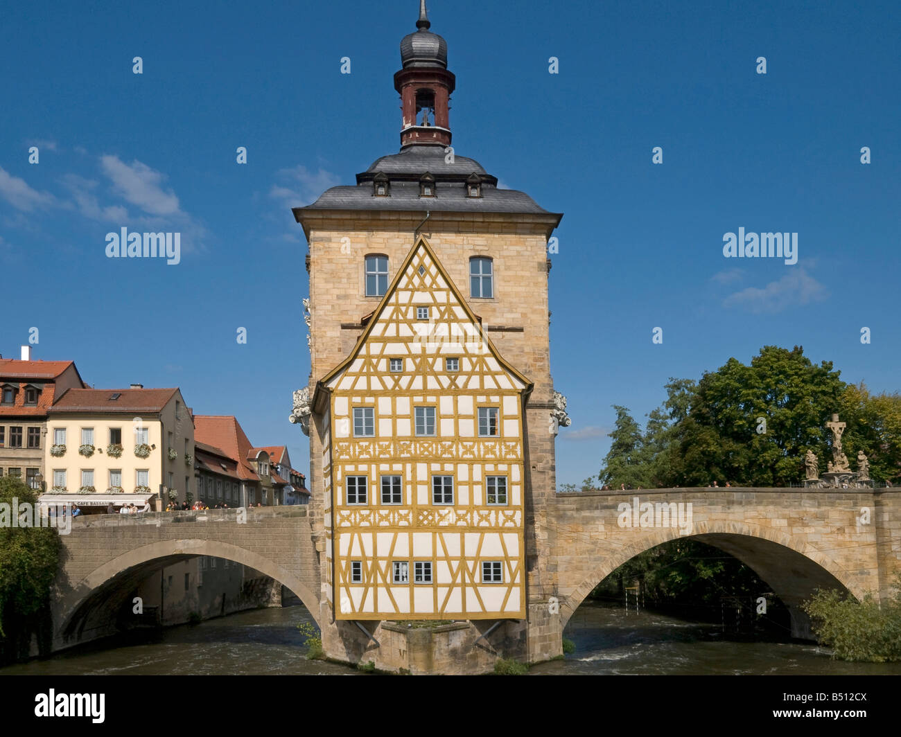 old town hall with tower and half timbered house and bridge over the ...