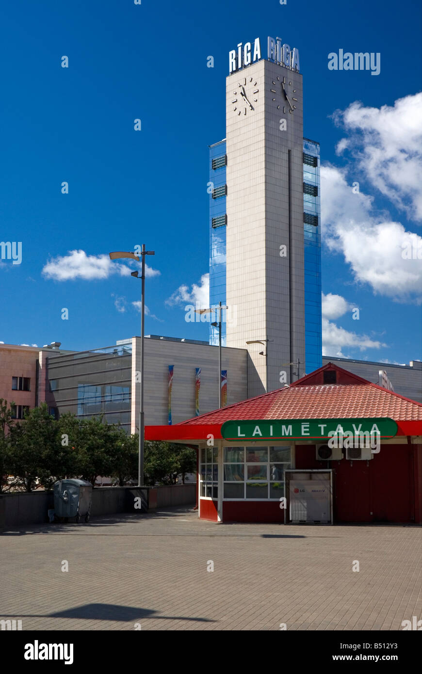 The clock tower of Riga central train station with stalls around it ...