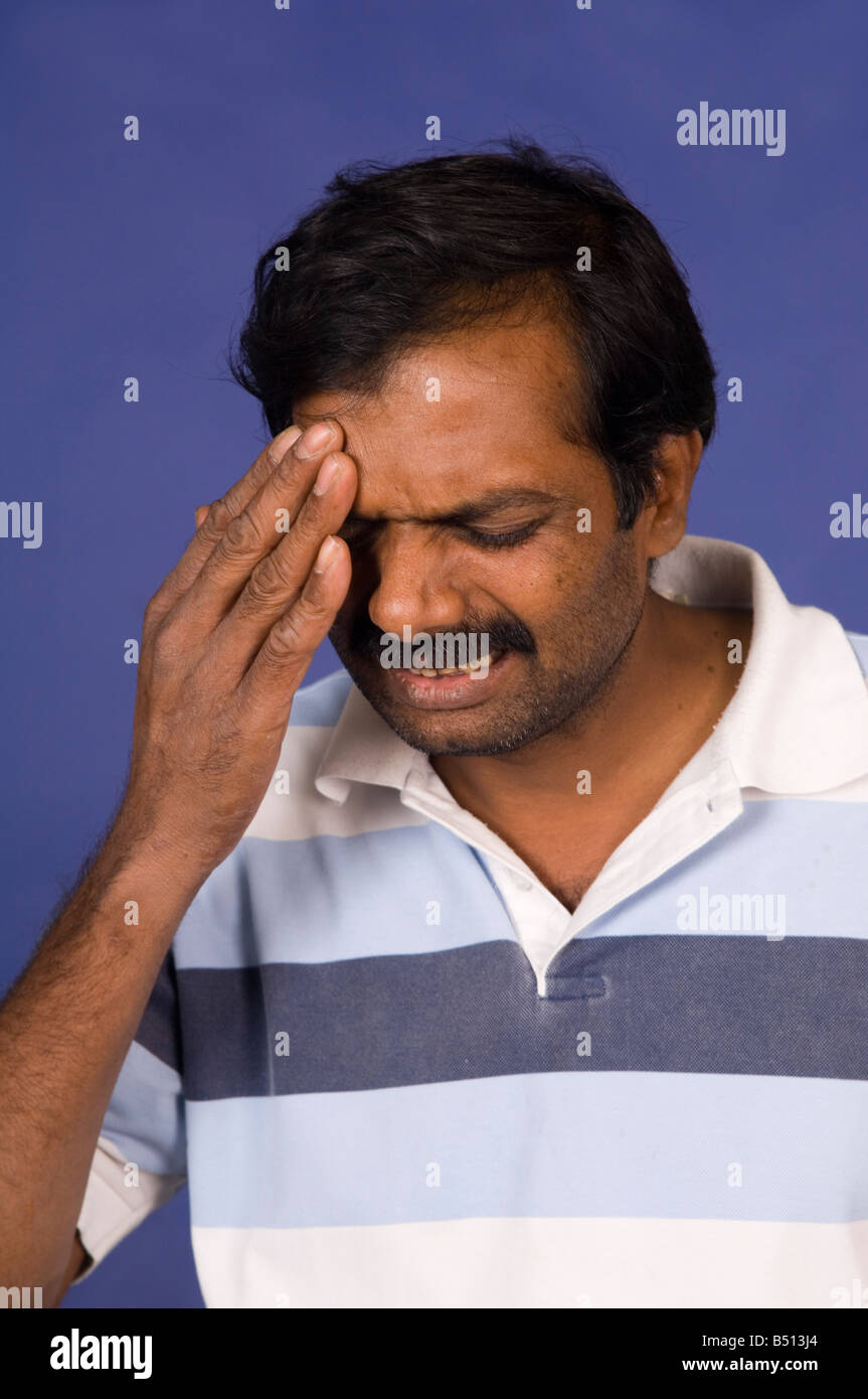 Indian man with a headache Stock Photo - Alamy