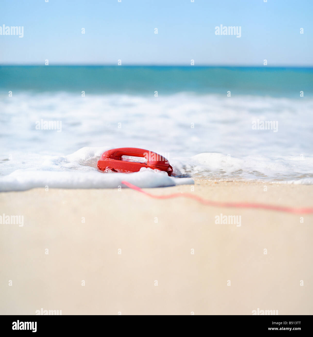 Landline telephone in surf on the beach Stock Photo - Alamy