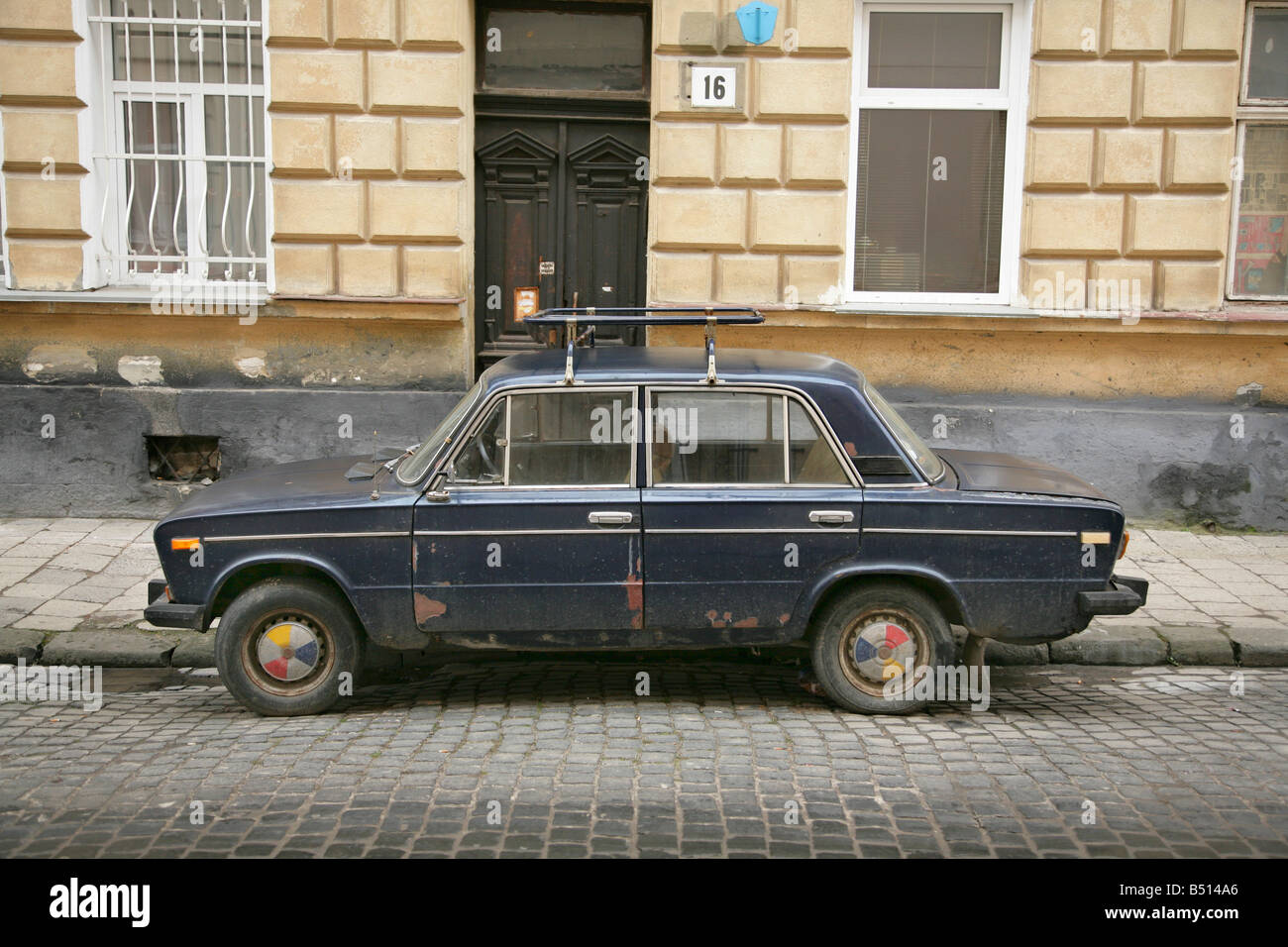 Old dirty dark blue Lada saloon car parked on a cobbled street in Kiev ...
