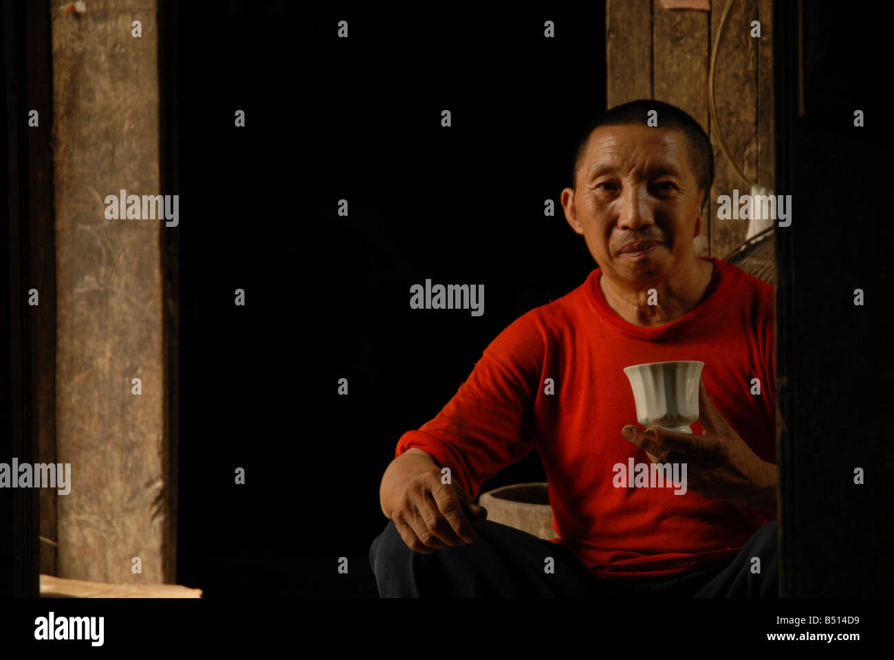 A farmer at home sipping tea in rural Chongqing Municipality, China ...