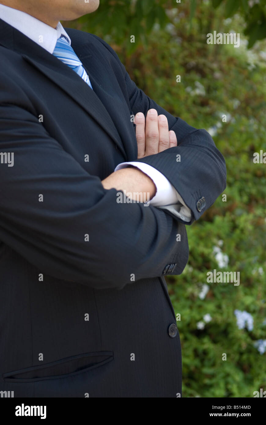 man in suit folding arms Stock Photo - Alamy