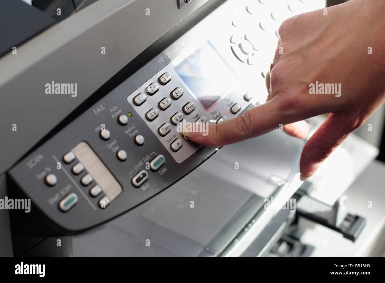 Woman is using a fax machine Stock Photo - Alamy