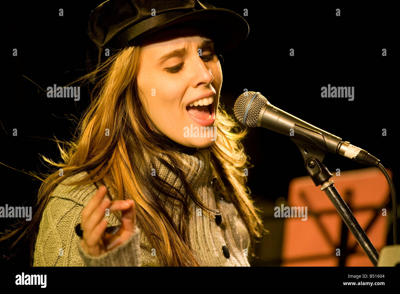 Young female singer performing a live concert Stock Photo - Alamy