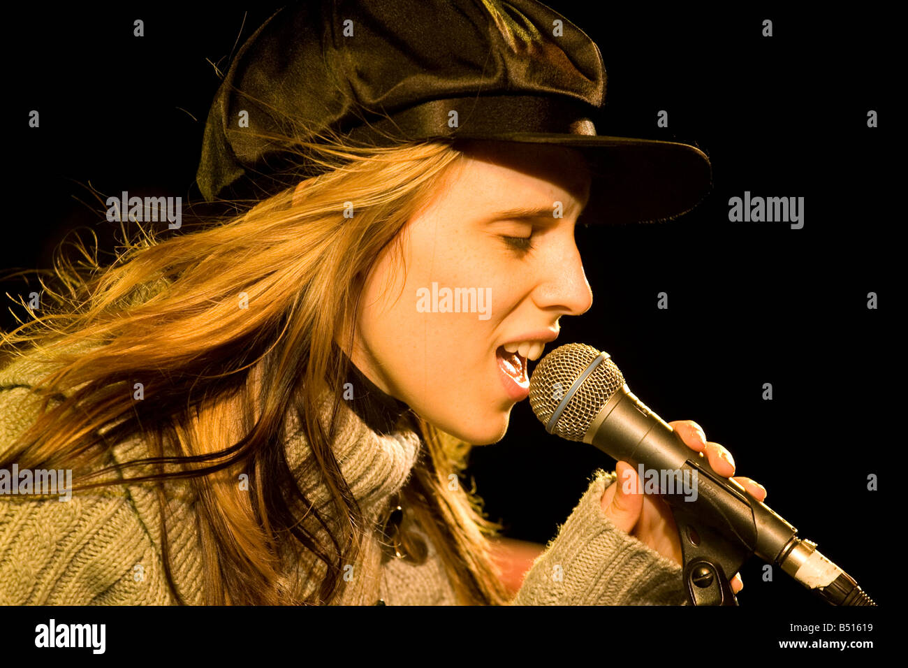 Young female singer performing a live concert Stock Photo - Alamy