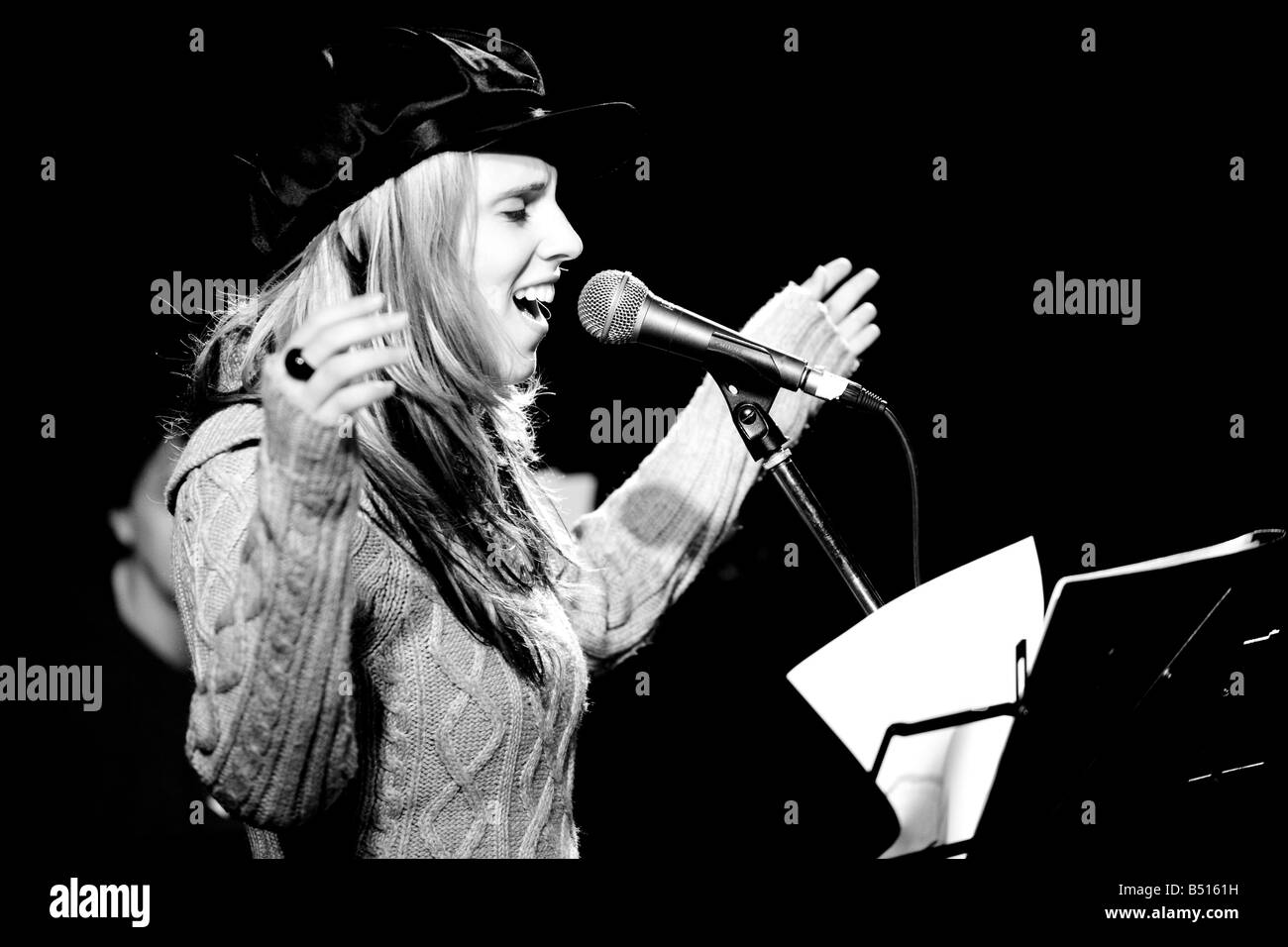 Young female singer performing a live concert Stock Photo - Alamy