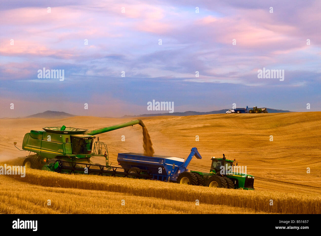 Combine harvester grain cart sunset hi-res stock photography and images ...