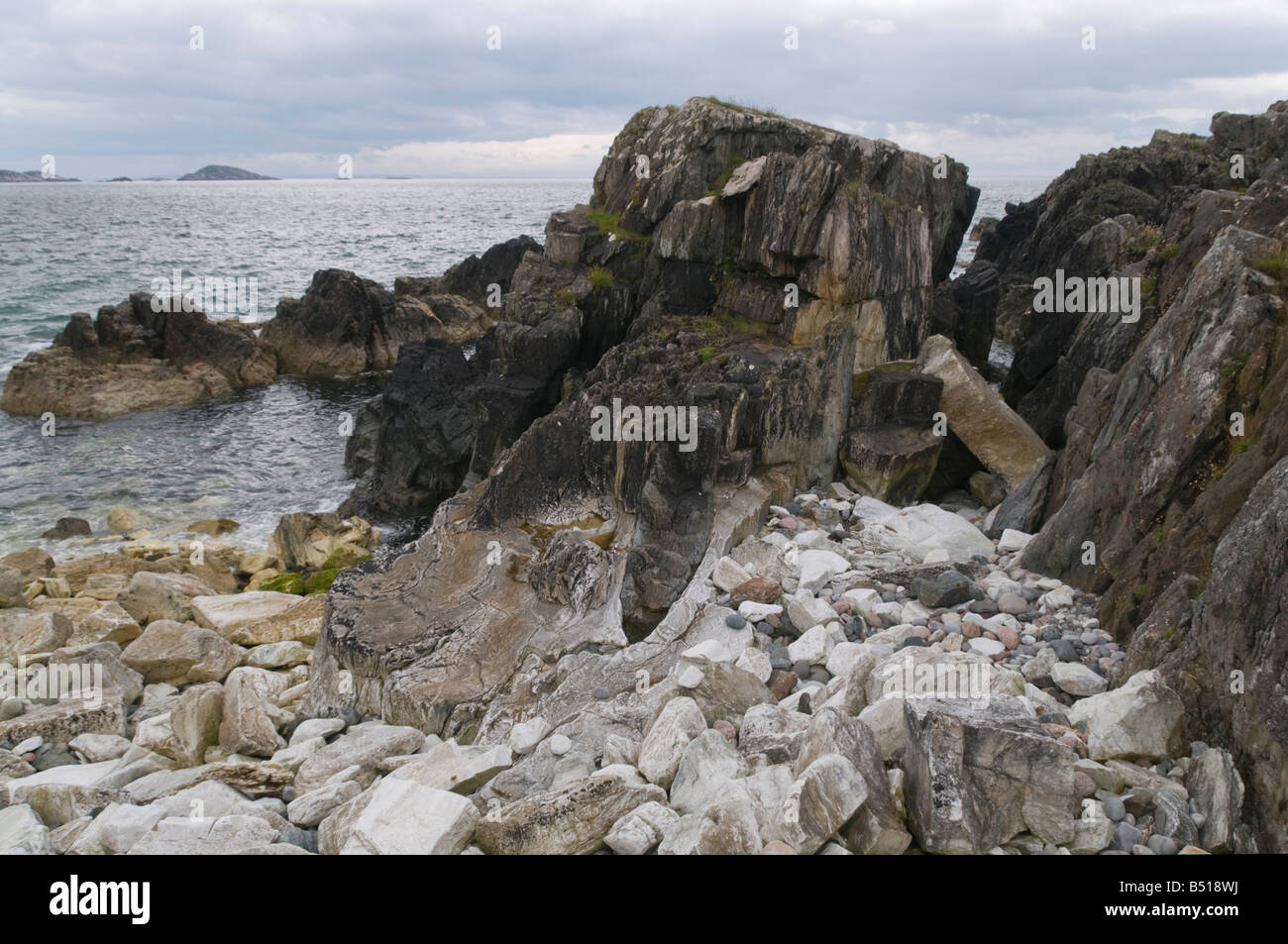 Rocks and view across sea at disused marble quarry on Iona; foreground ...