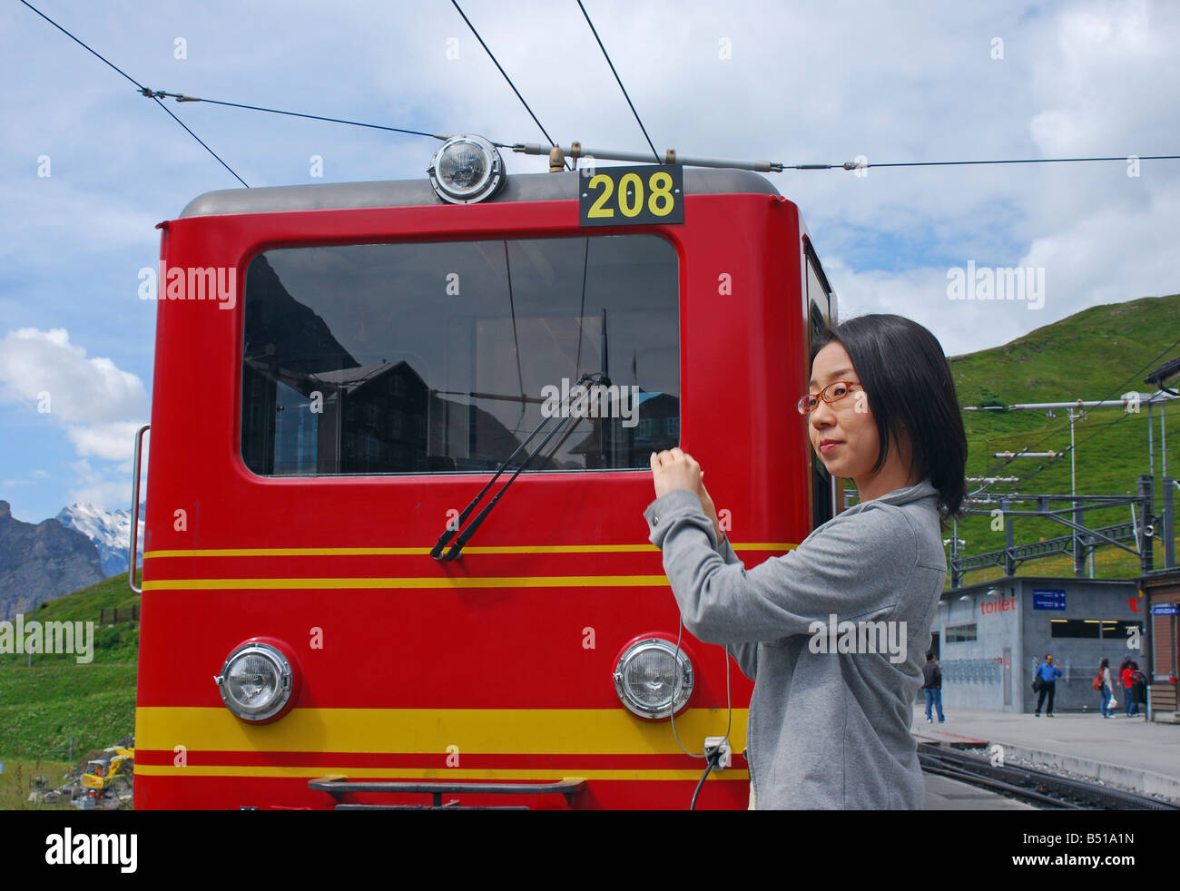 Jungfraubahn train and Japanese tourist preparing to take a picture of ...