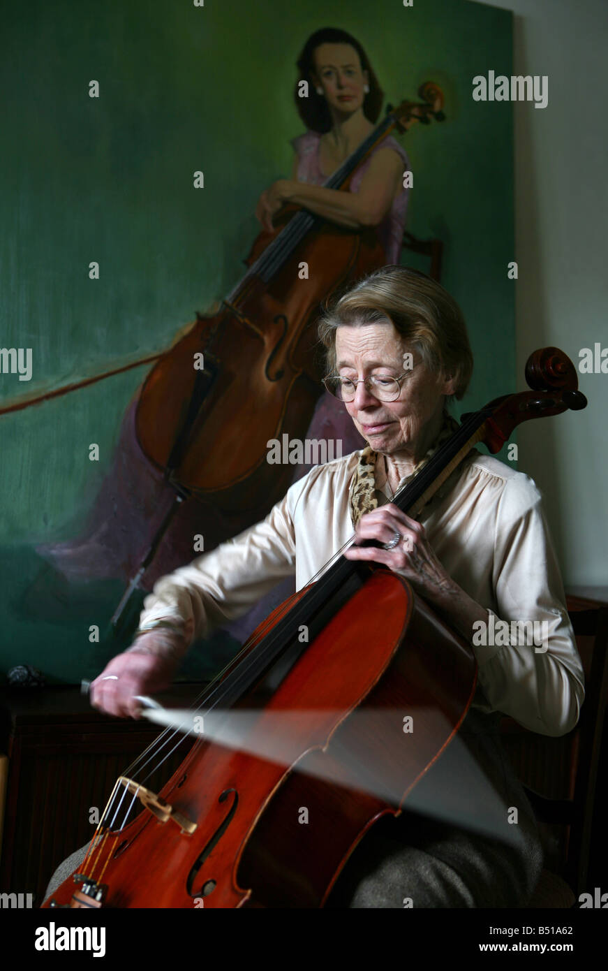 Elderly woman cellist with oil painting from her younger years Stock ...