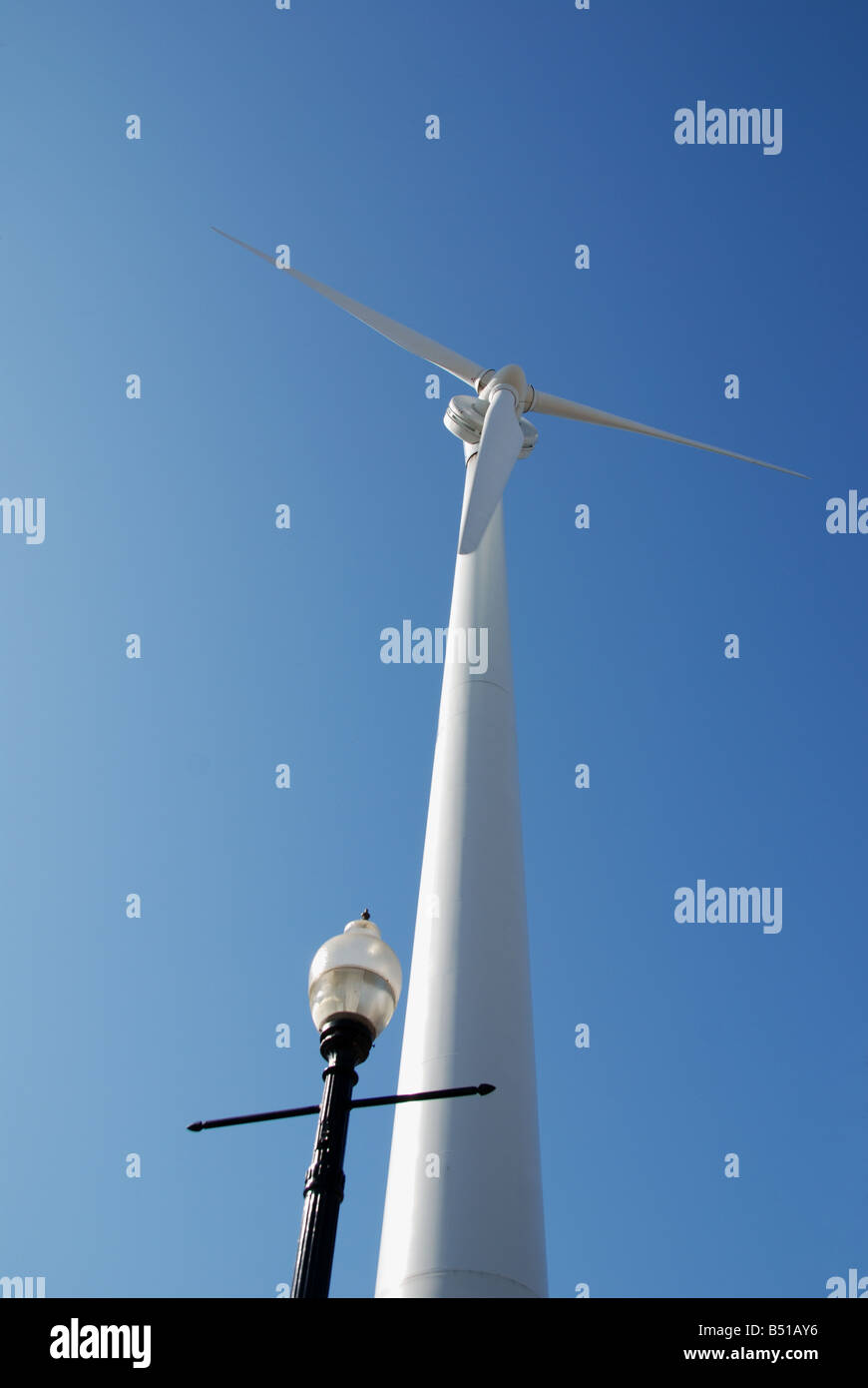 A wind turbine generator with an old fashioned lamp post in the ...