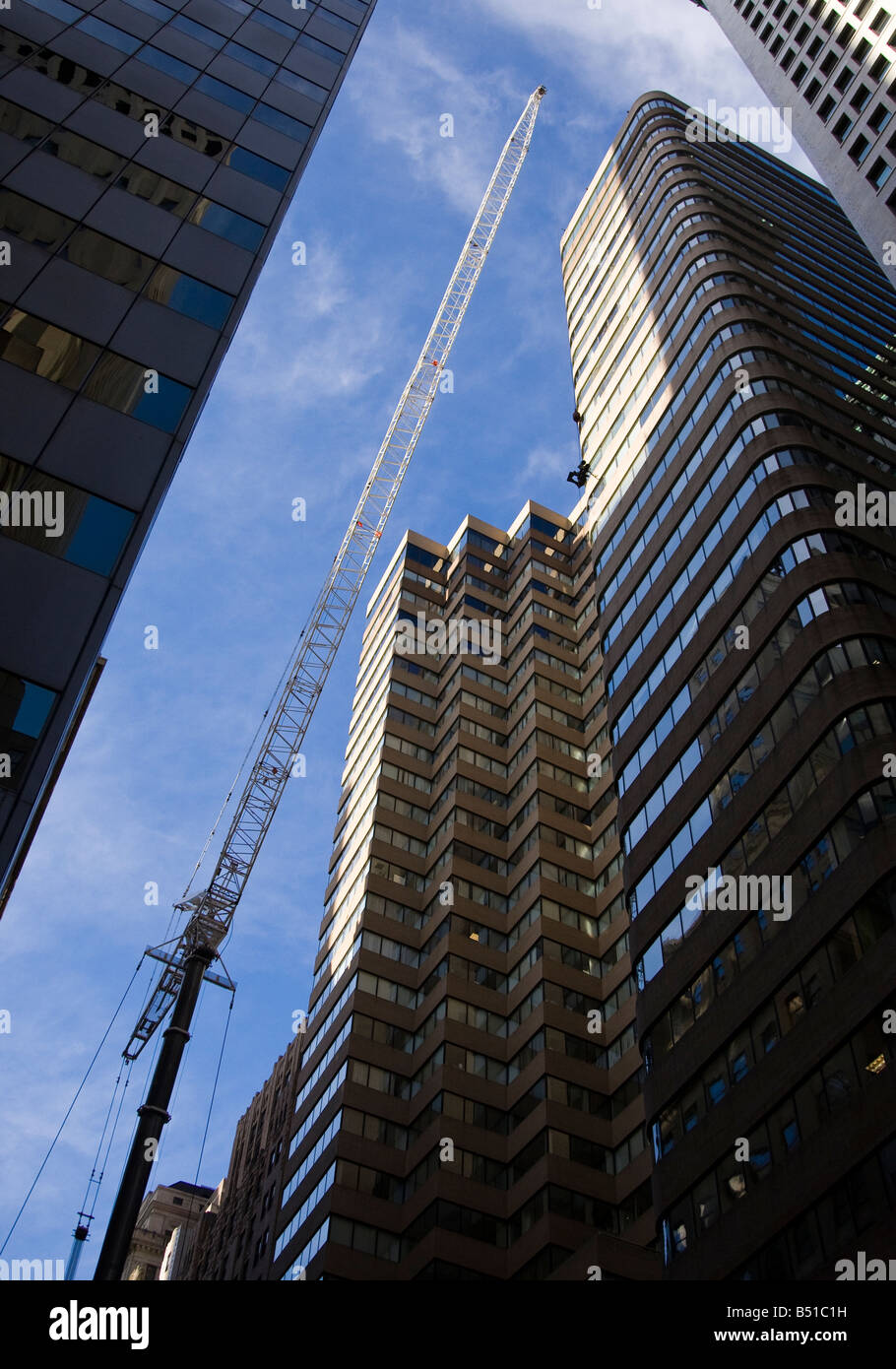 Crane lifting equipment to the top of a building Stock Photo - Alamy