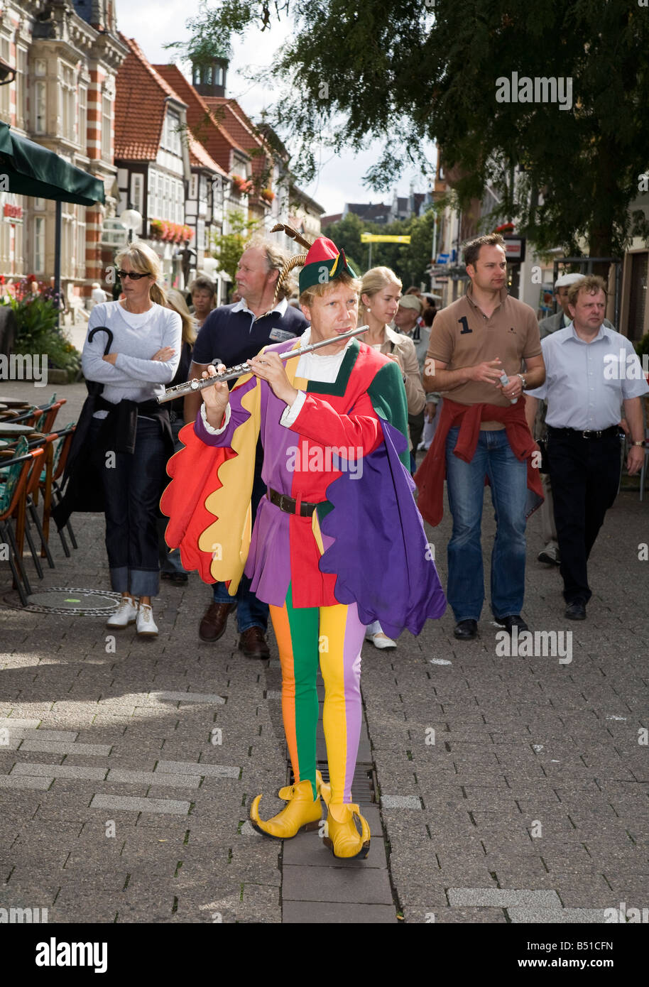 Tourists with man dressed as Pied Piper of Hamelin leading group ...