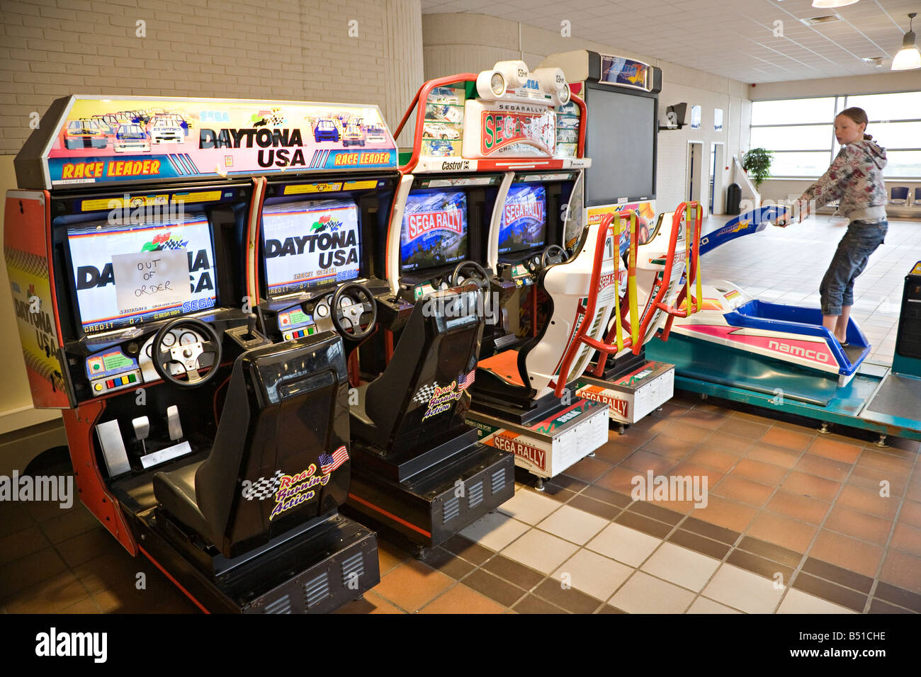 Girl playing on game machine in arcade Dunkirk France Stock Photo - Alamy
