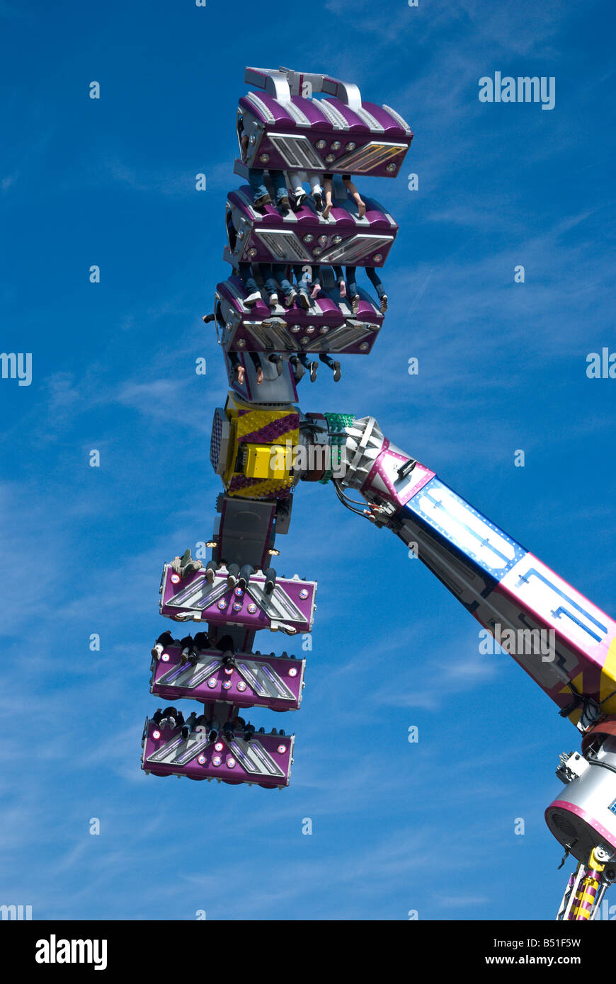 High speed thrilling carnival ride on brilliant blue sky background ...