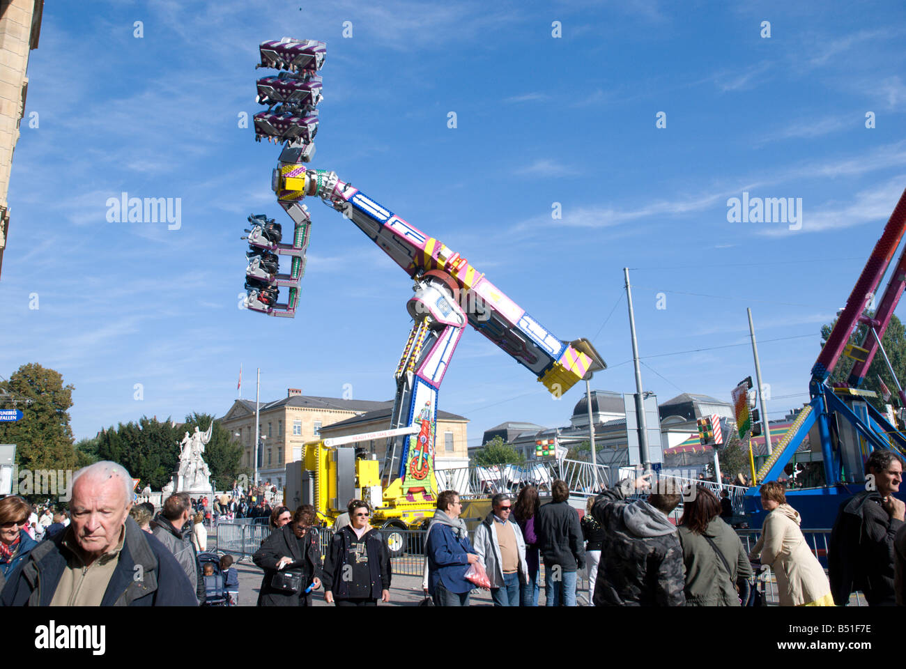 High speed thrilling carnival ride on brilliant blue sky background ...