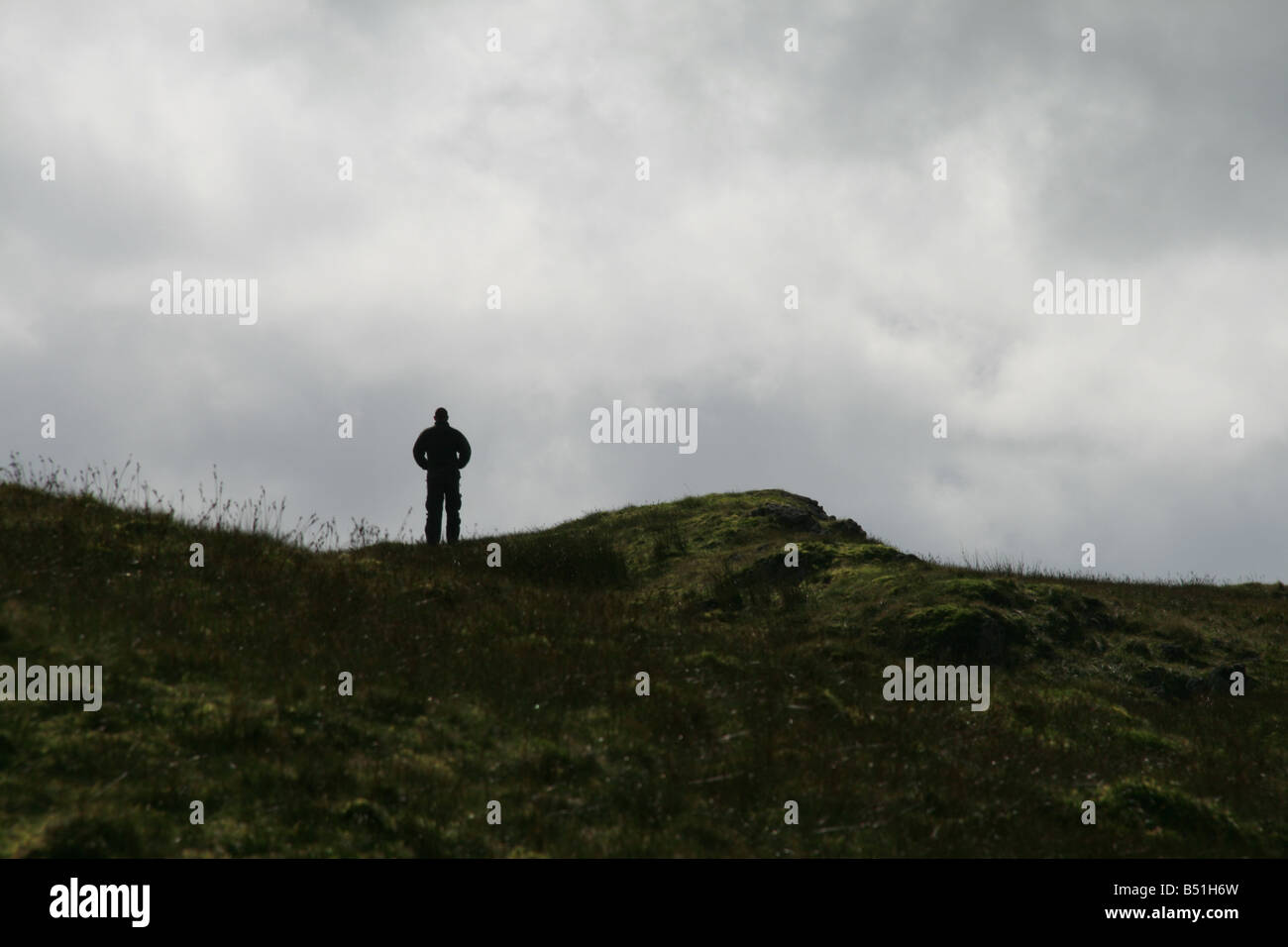 man walking on wild rugged rural mountain top Stock Photo - Alamy