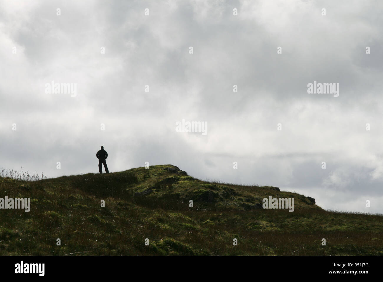 man walking on wild rugged rural mountain top Stock Photo - Alamy