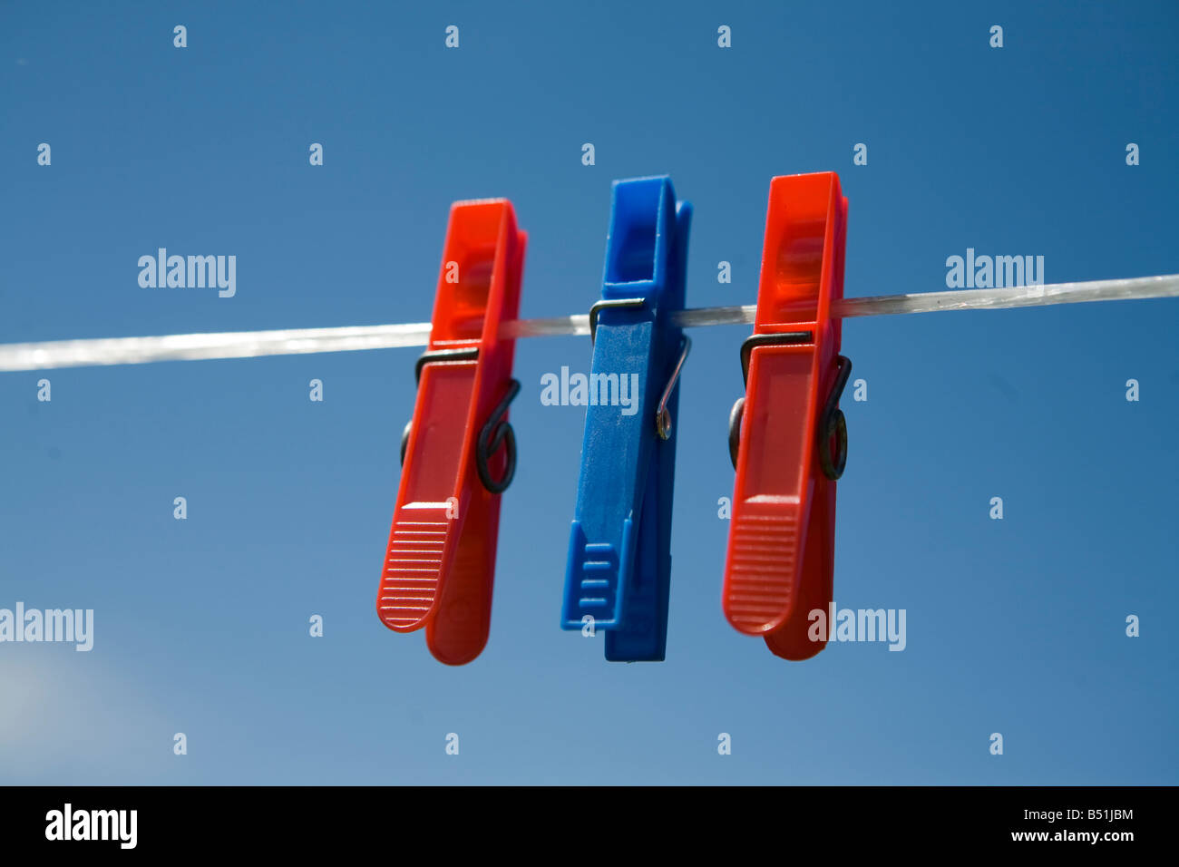 red blue red linen clips on a clothesline Stock Photo - Alamy