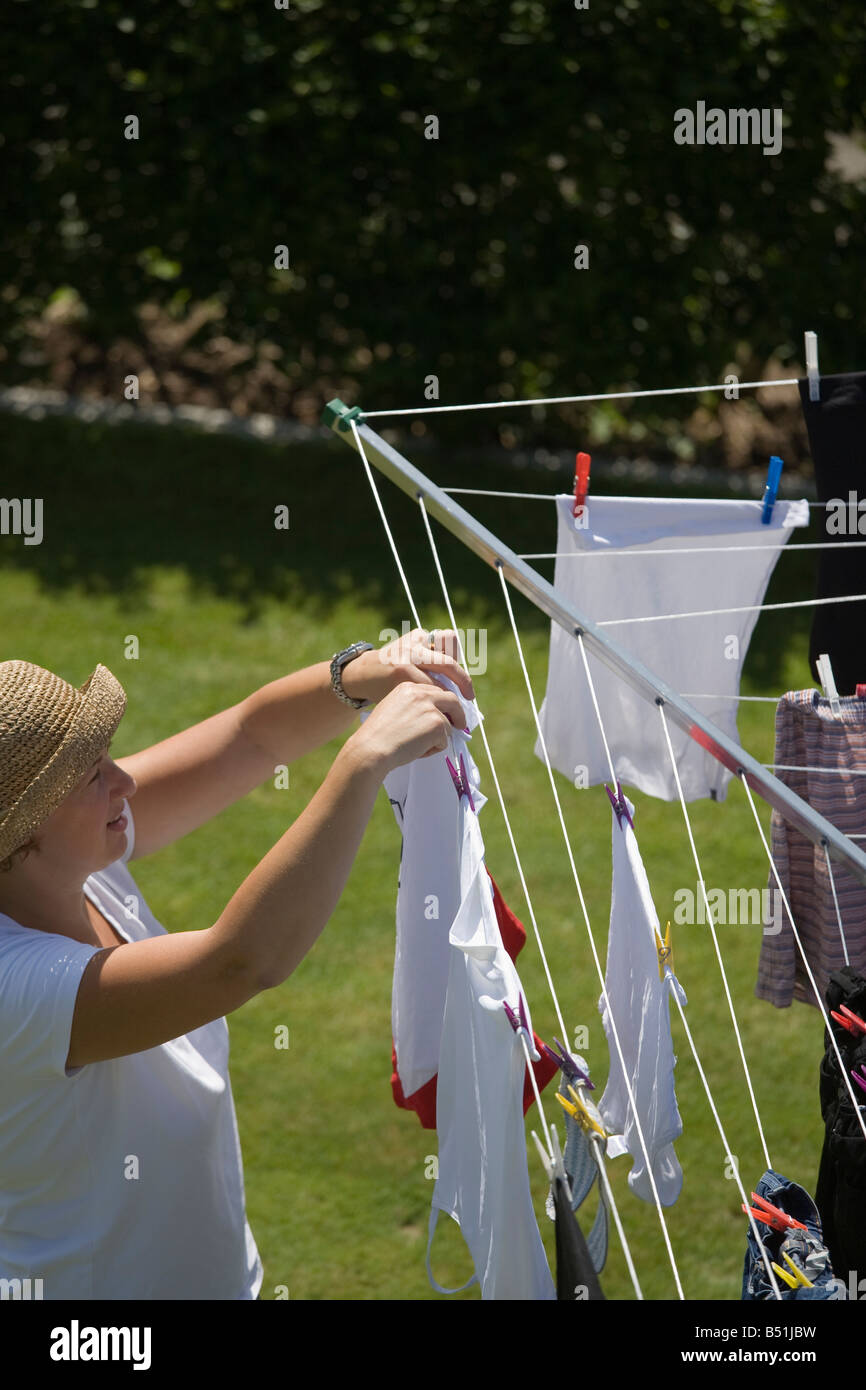 Woman hanging laundry Stock Photo - Alamy
