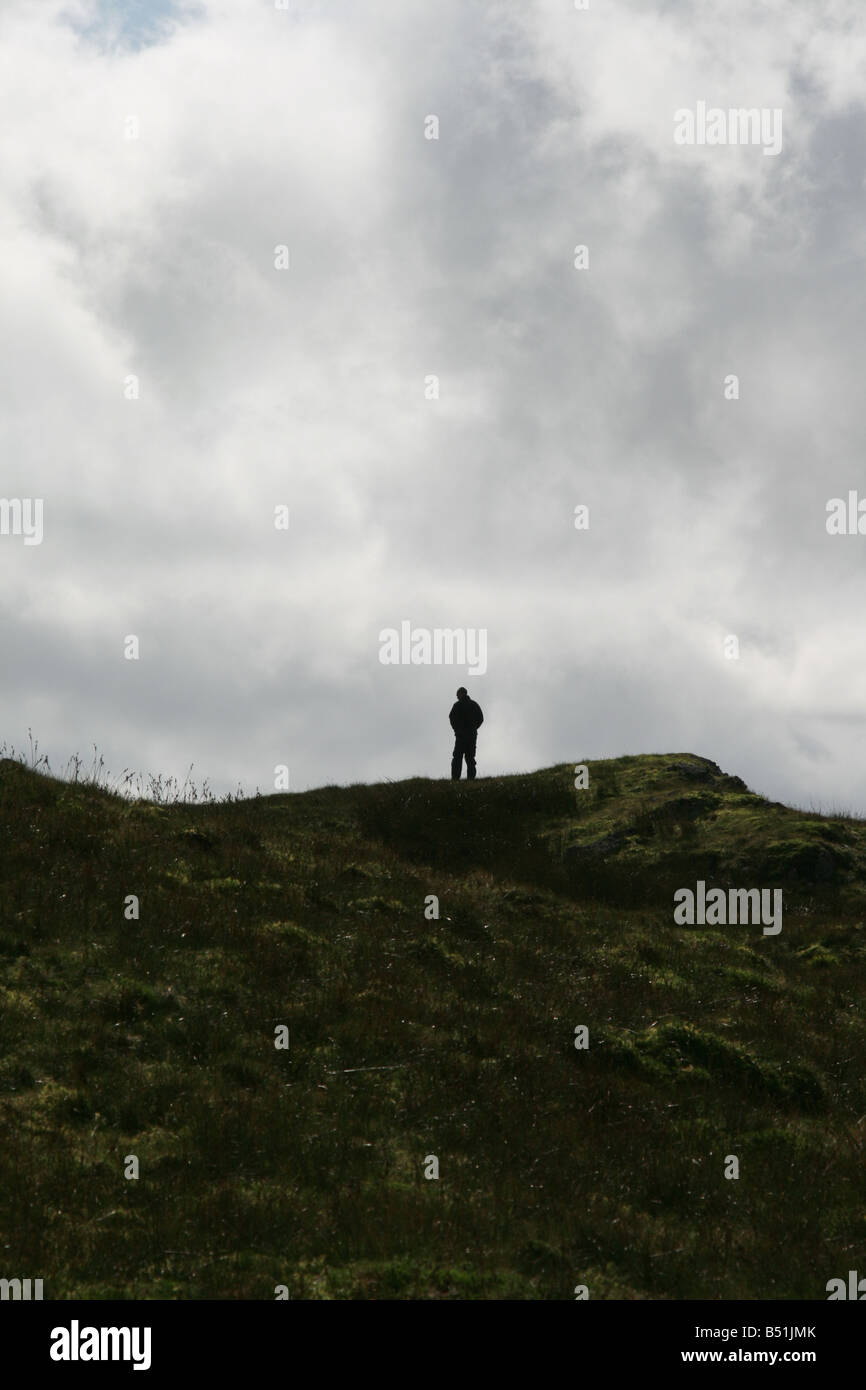 man walking on wild rugged rural mountain top Stock Photo - Alamy