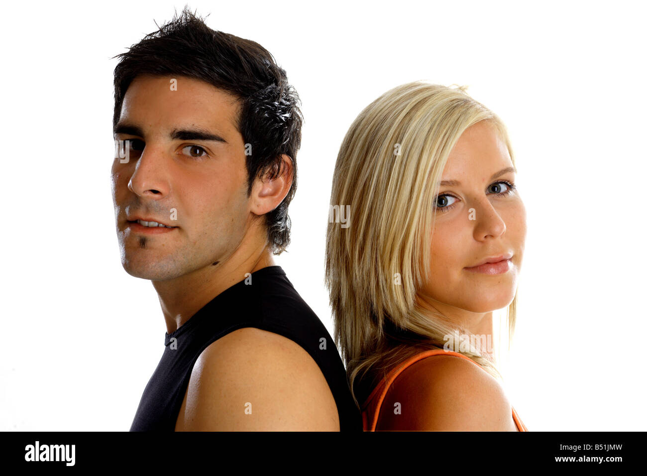 Young Couple standing back to back Stock Photo - Alamy