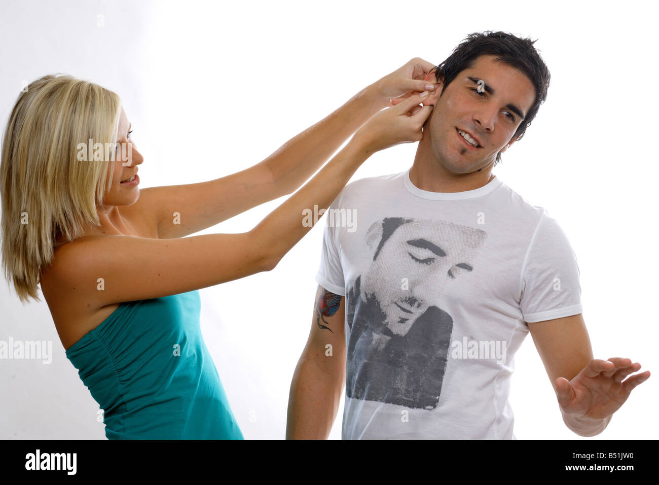 Young woman pulls man on the ear Stock Photo - Alamy
