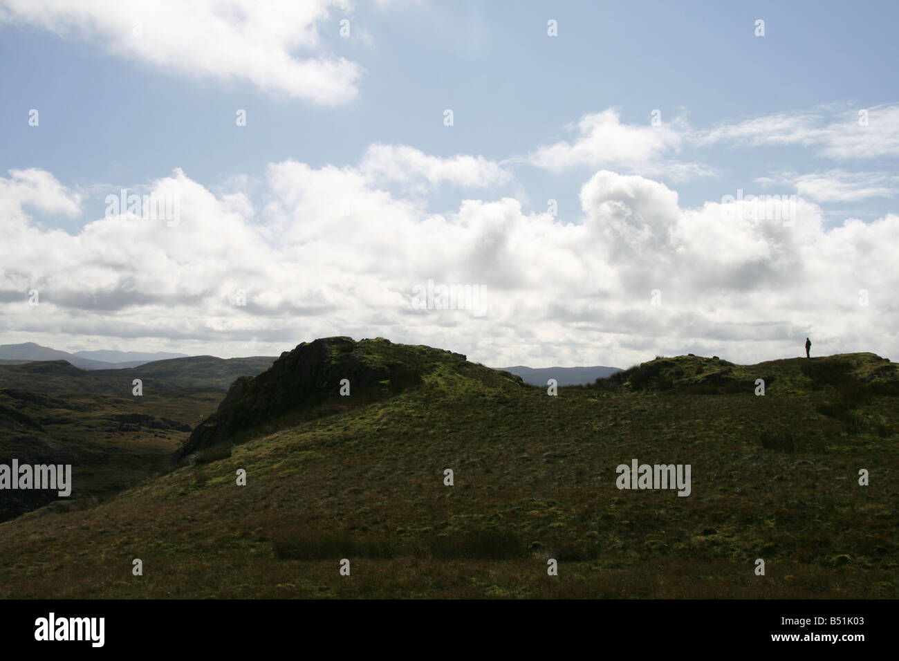 man walking on wild rugged rural mountain top Stock Photo - Alamy