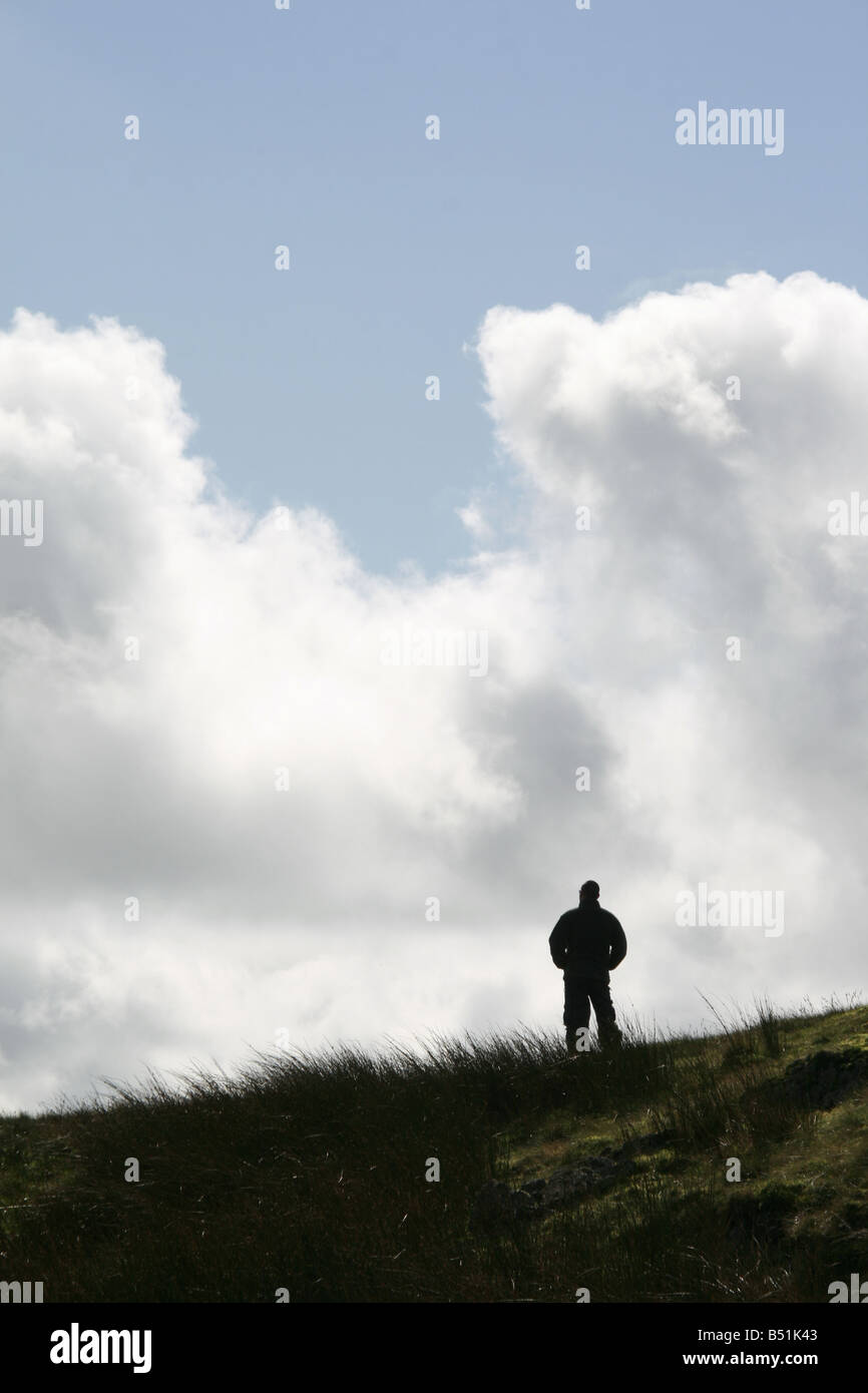 man walking on wild rugged rural mountain top Stock Photo - Alamy