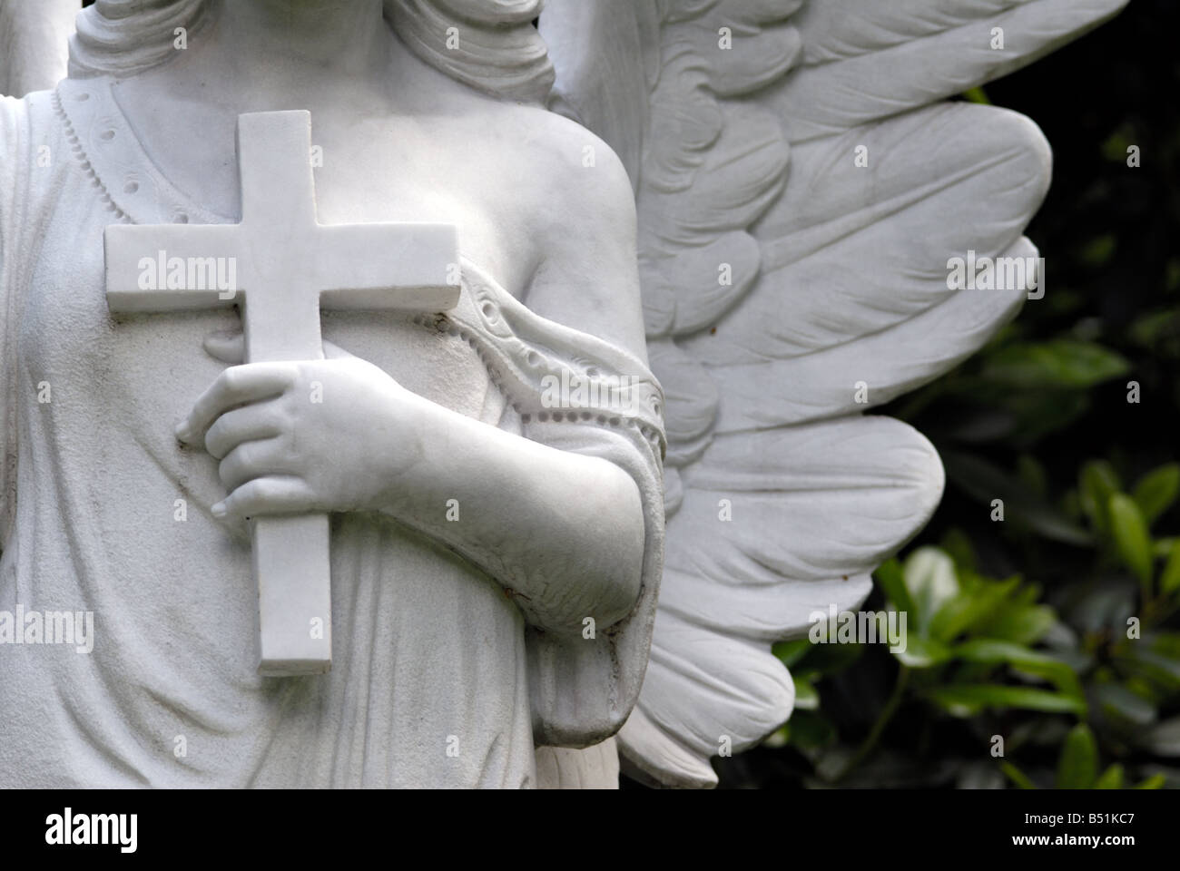 Angel statue with a cross Stock Photo - Alamy