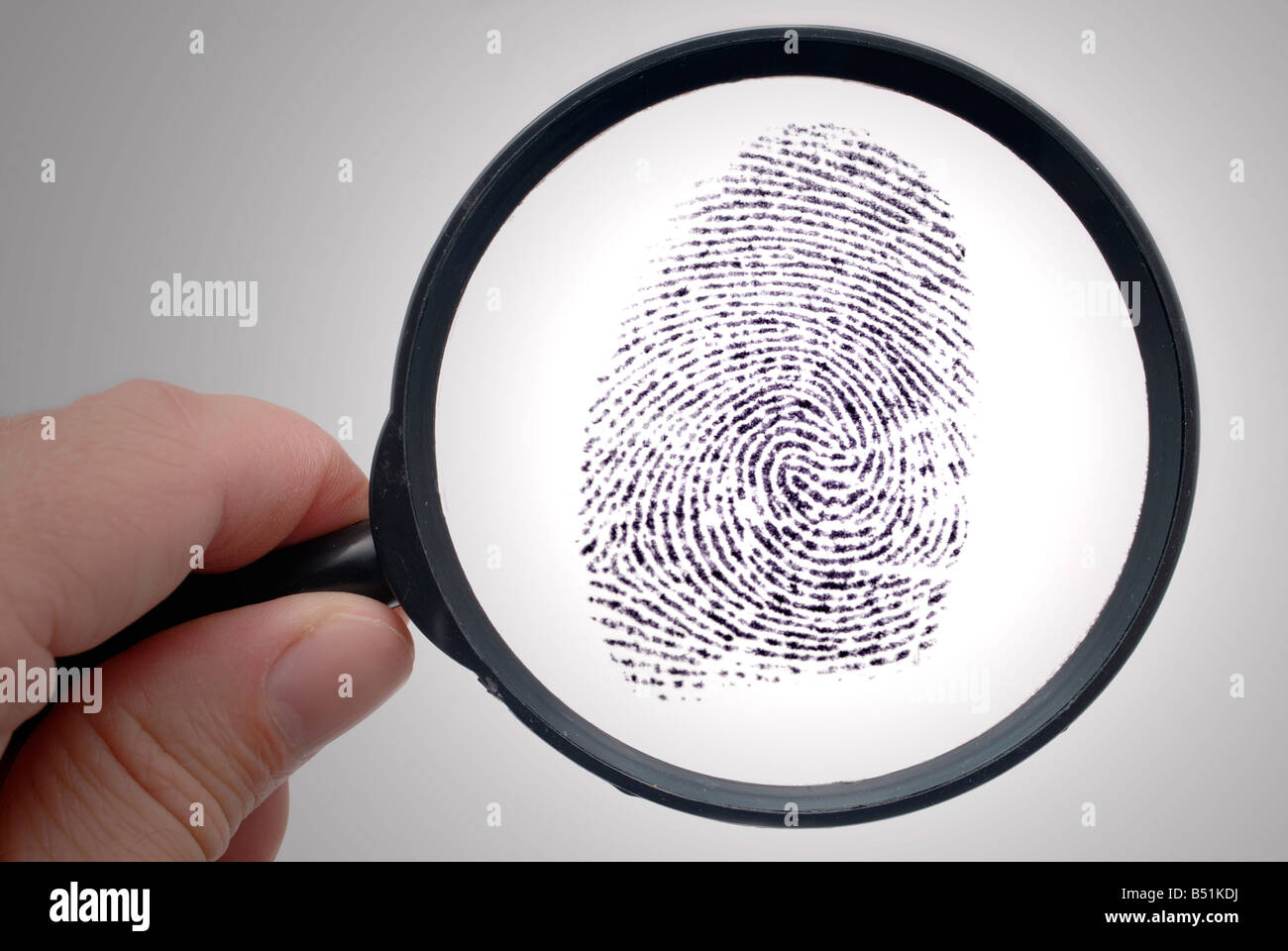 Hand with magnifying glass investigated fingerprint Stock Photo - Alamy