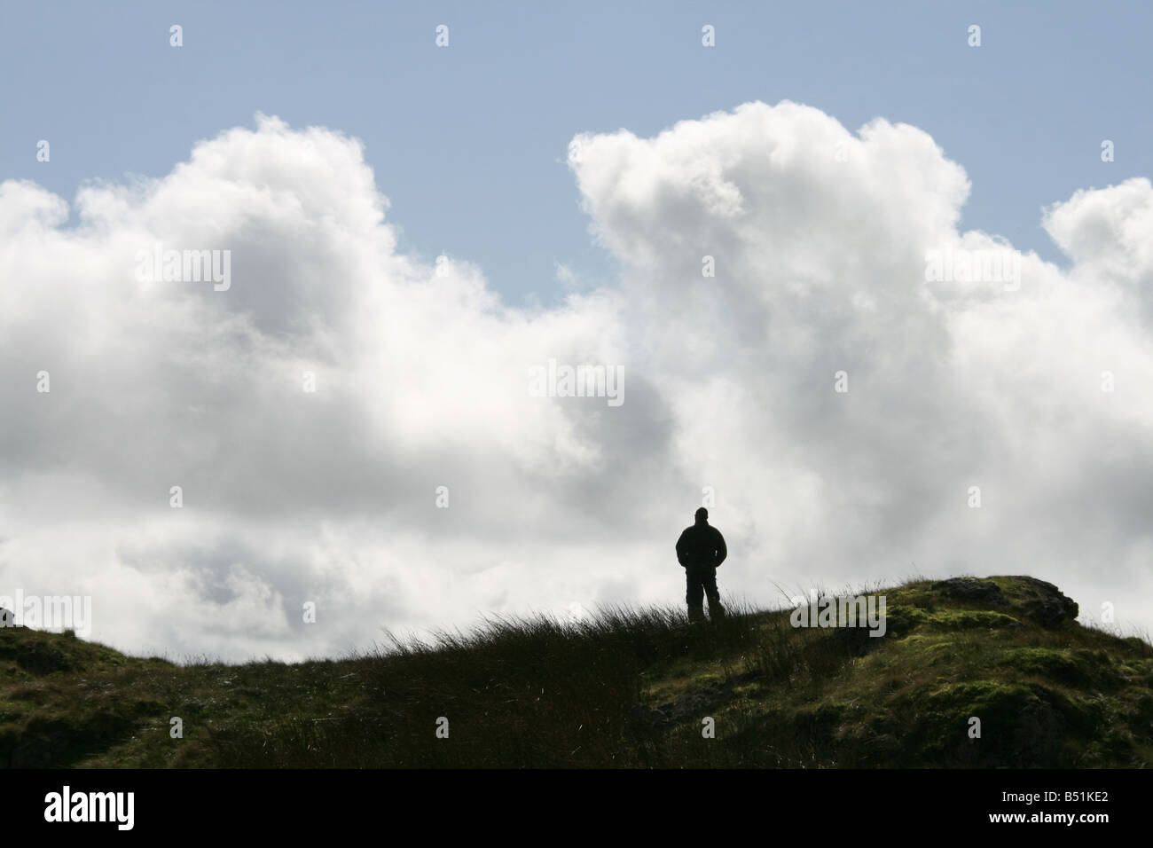 man walking on wild rugged rural mountain top Stock Photo - Alamy