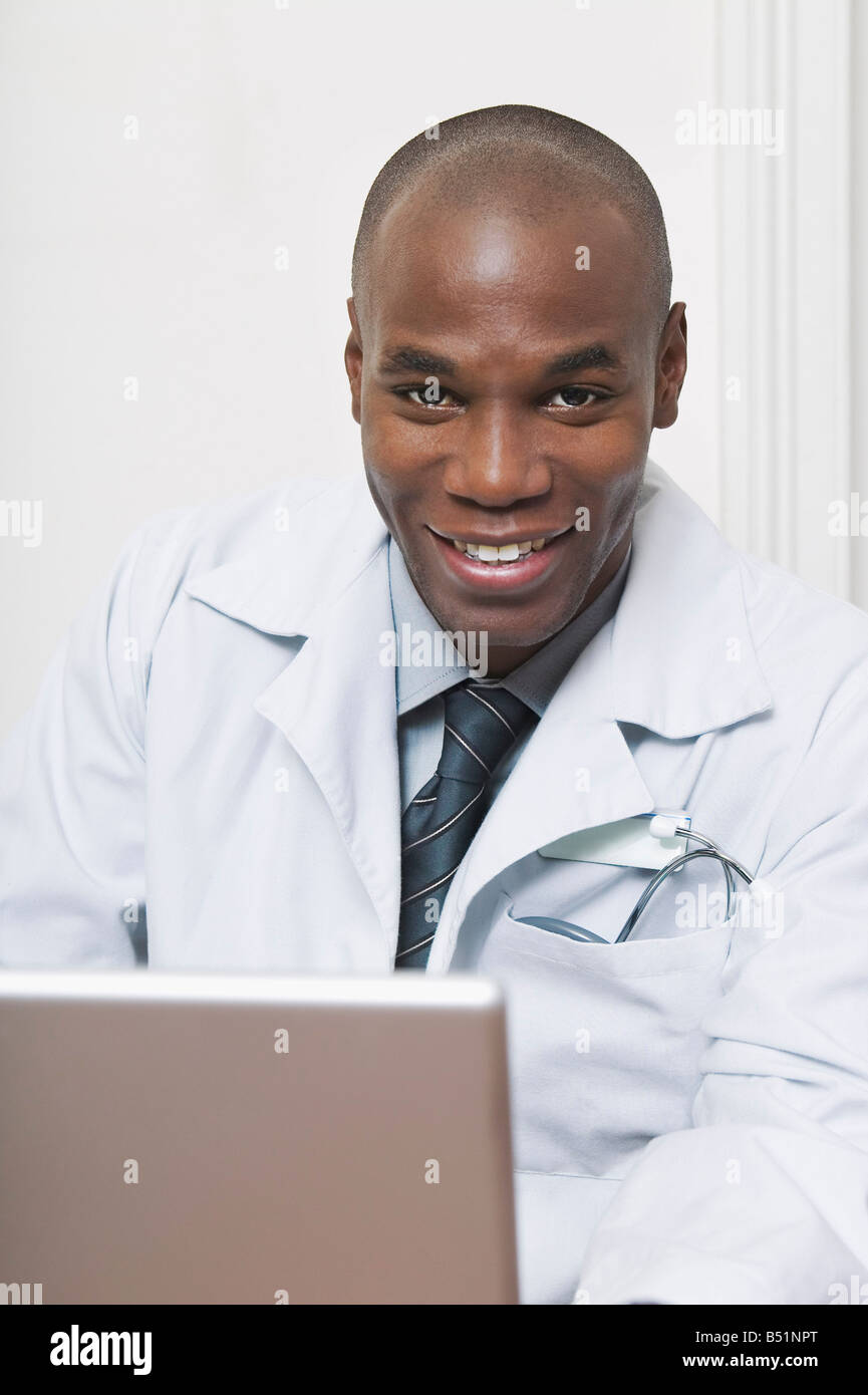 Physician Sitting Behind Desk Stock Photo - Alamy