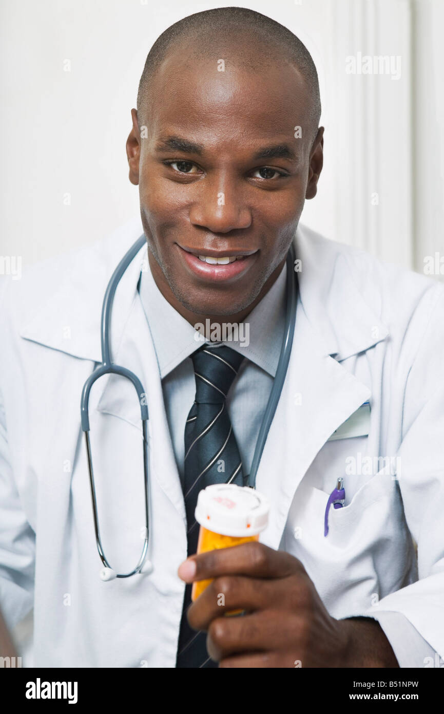 Physician Sitting Behind Desk Stock Photo - Alamy