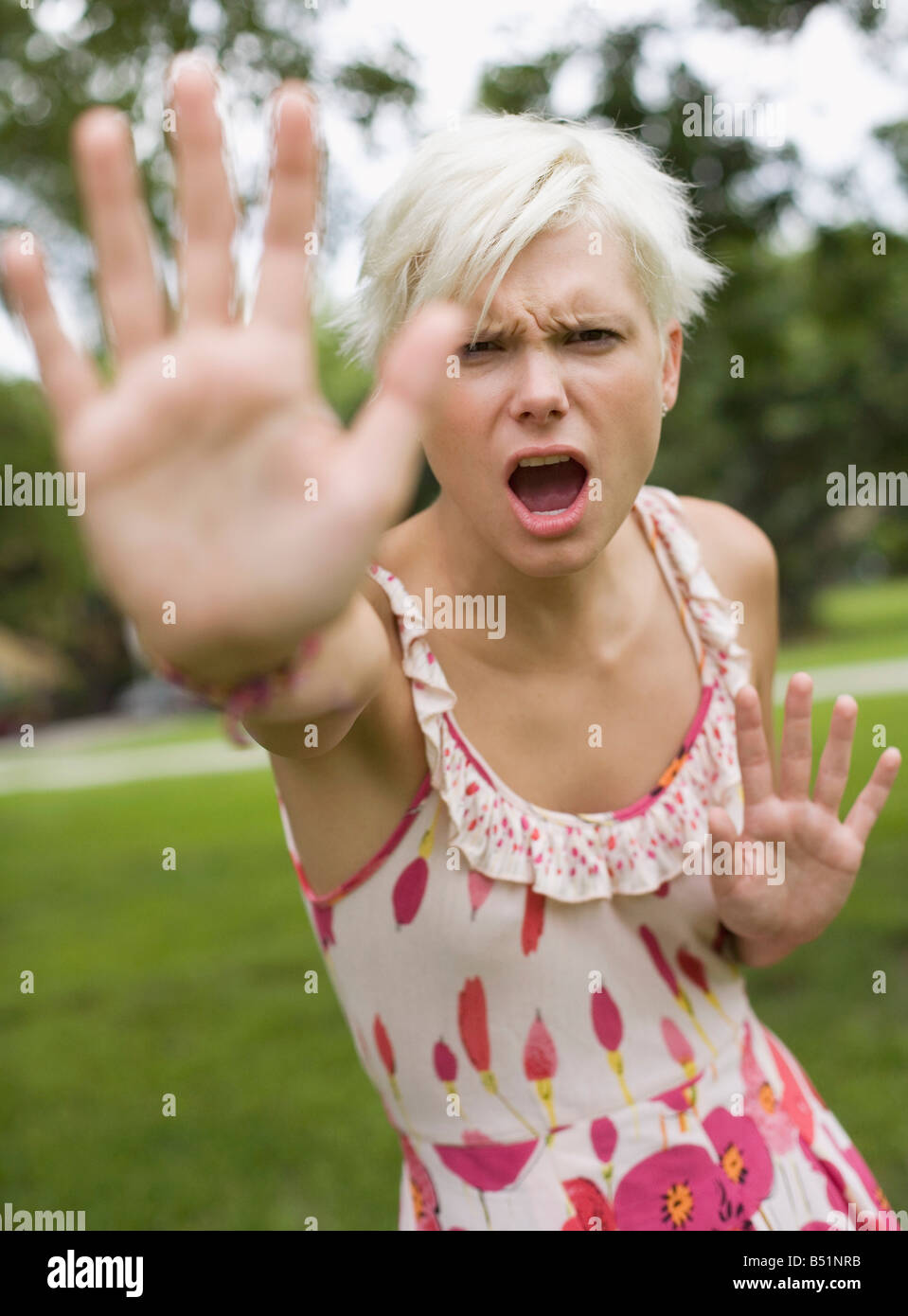 Young Angry Woman Making Hand Gesture in Defence Stock Photo - Alamy