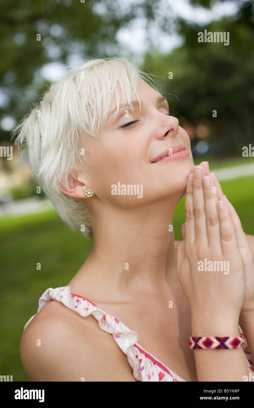 Woman praying outdoors on hi-res stock photography and images - Alamy