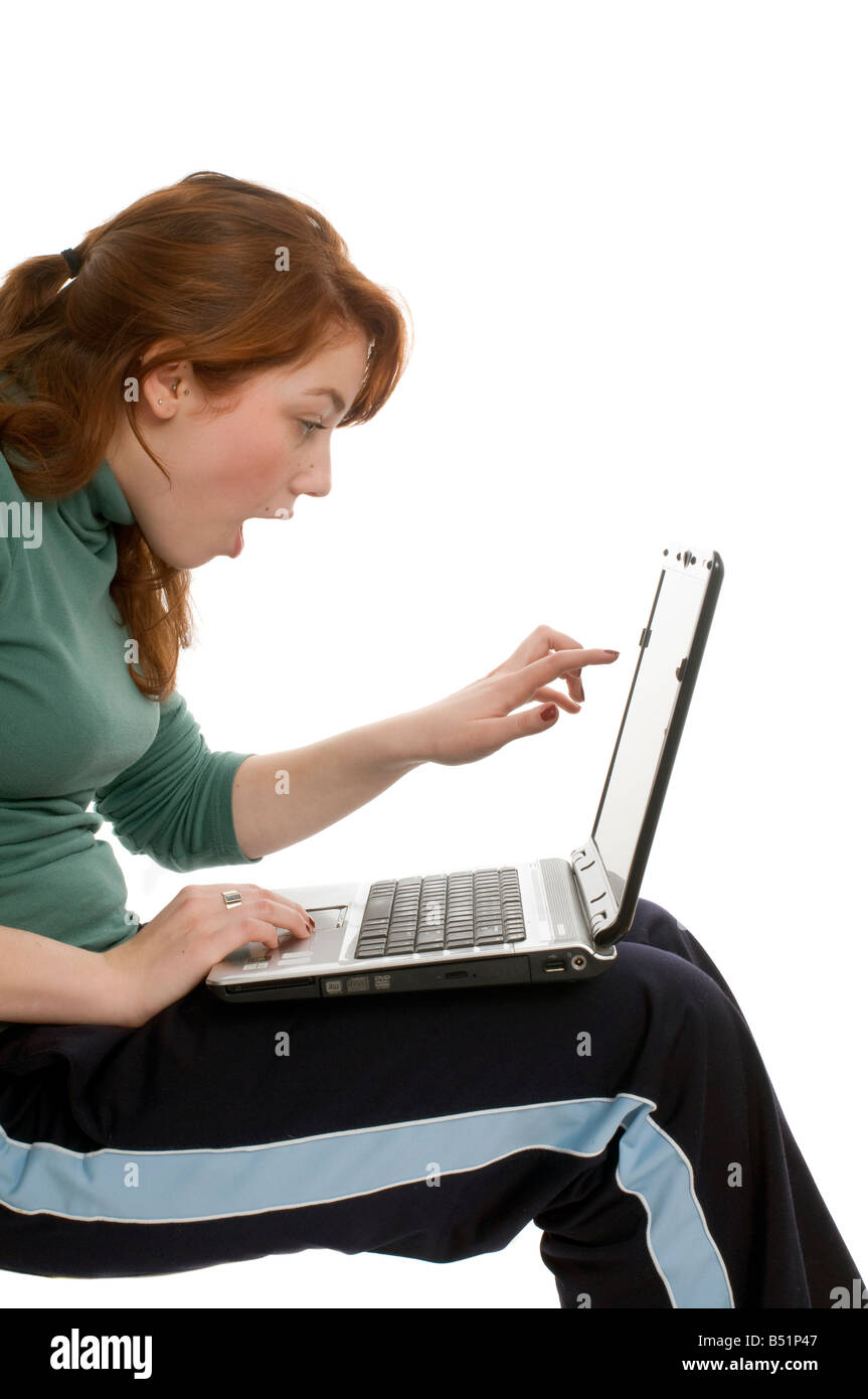 Surprised young woman with laptop Stock Photo - Alamy