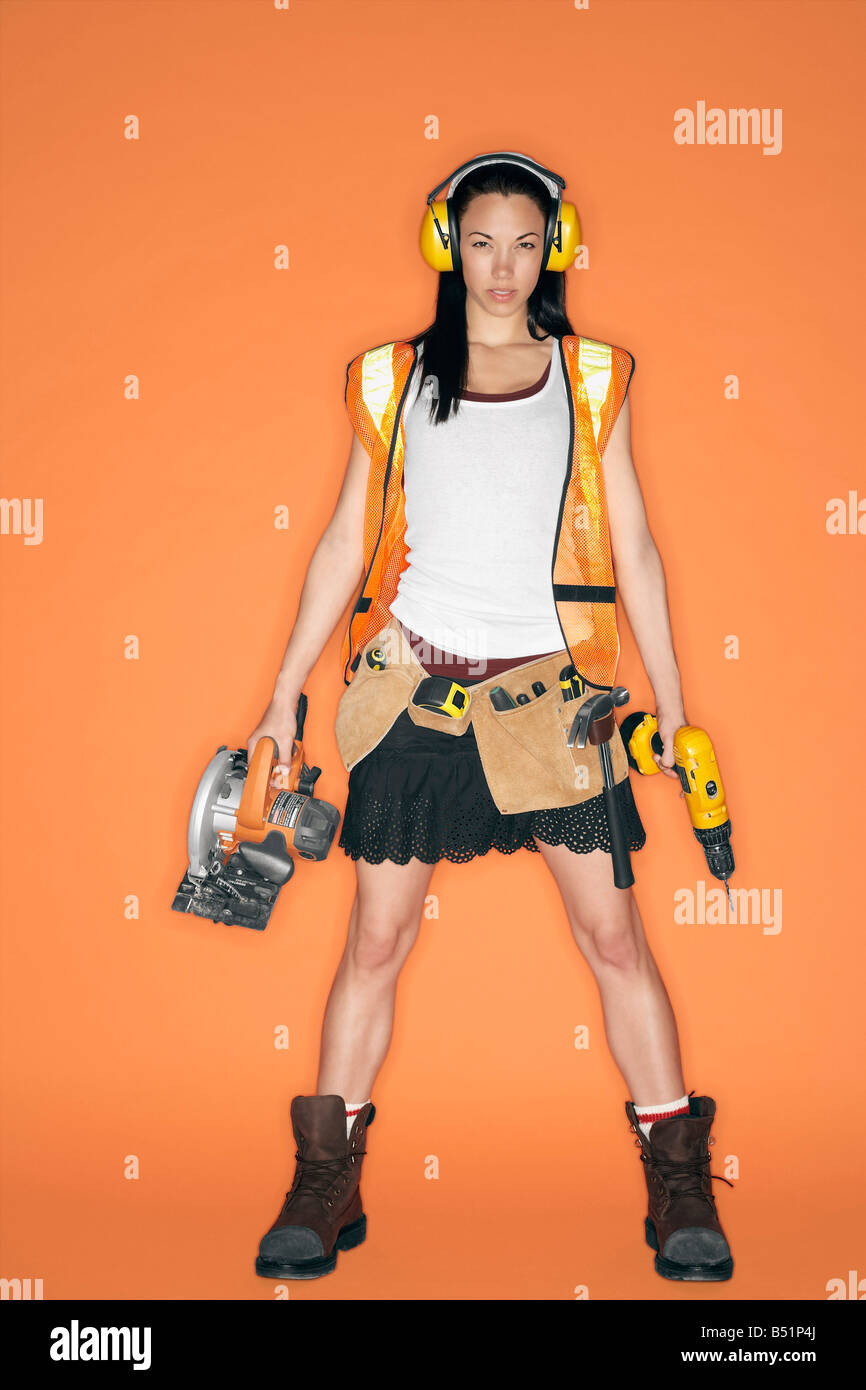 Young woman holding hammer drill hi-res stock photography and images ...