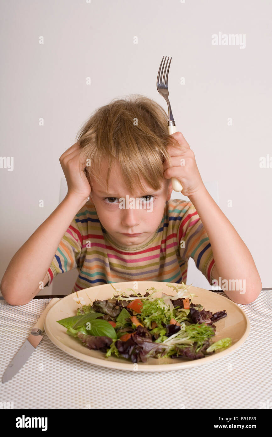 Boy Refusing to Eat Salad Stock Photo - Alamy